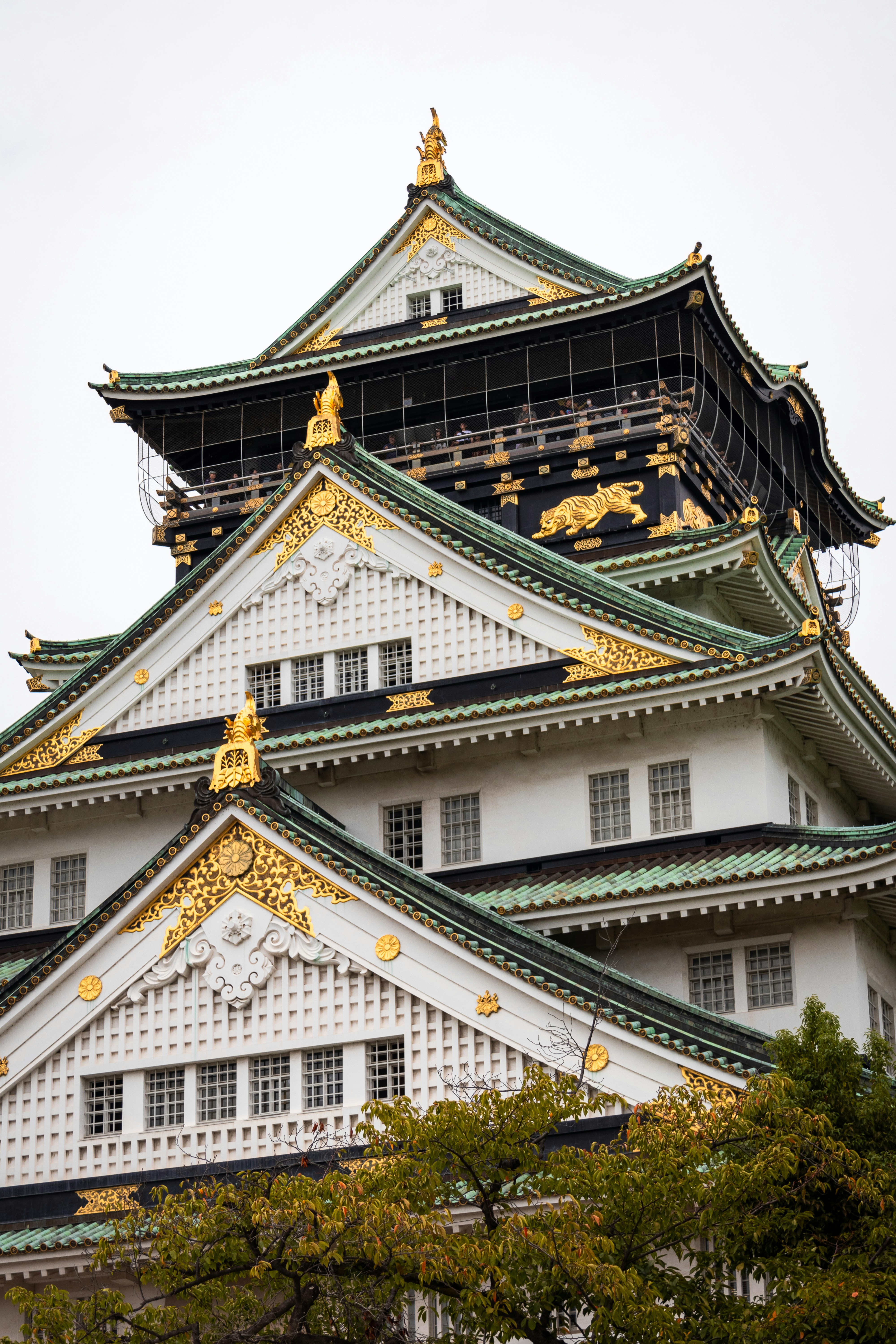 Ornate Tokyo Castle: Golden Rooflines Against a Clean Sky