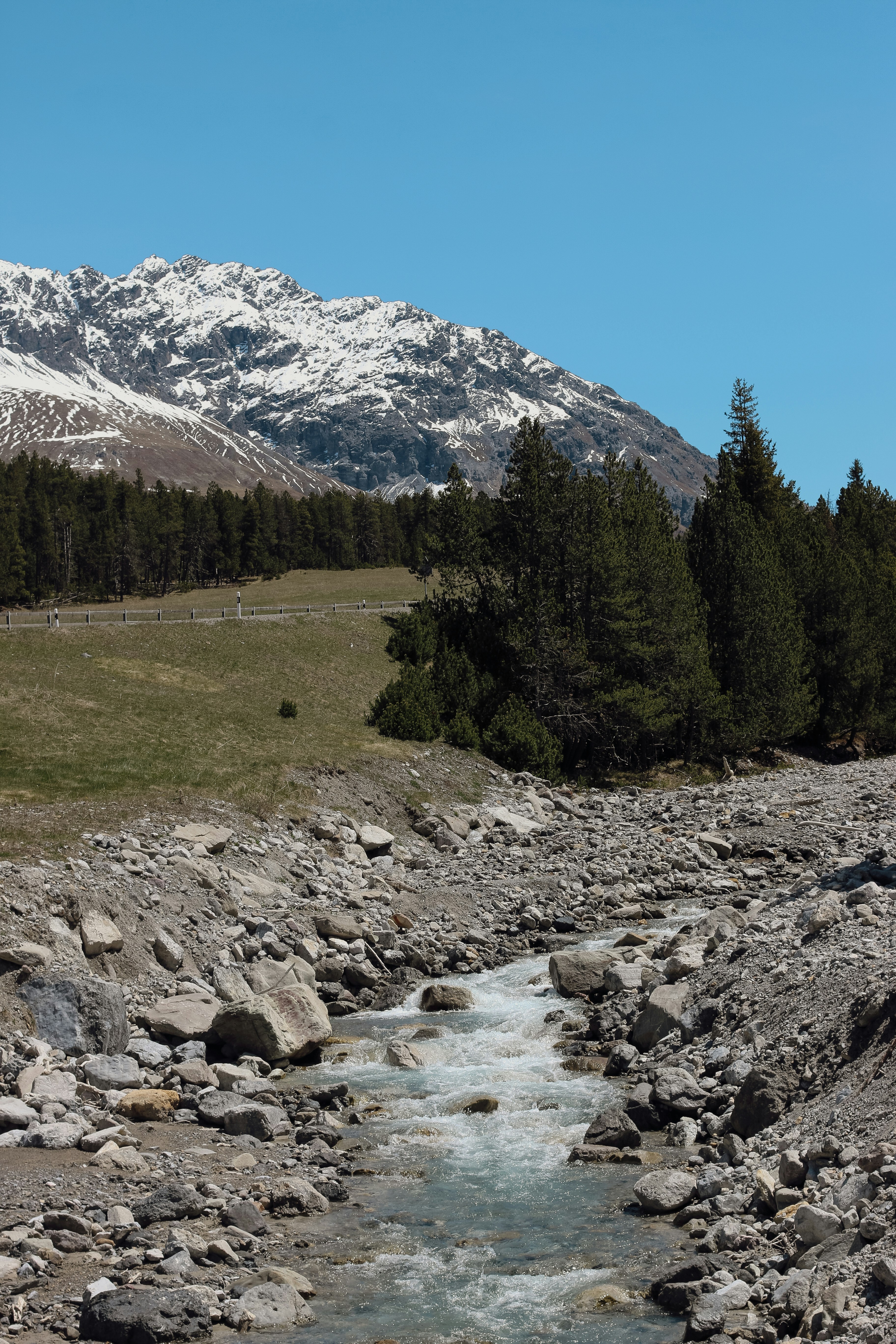 Snow-dusted Peaks Over a Frosted Riverbank