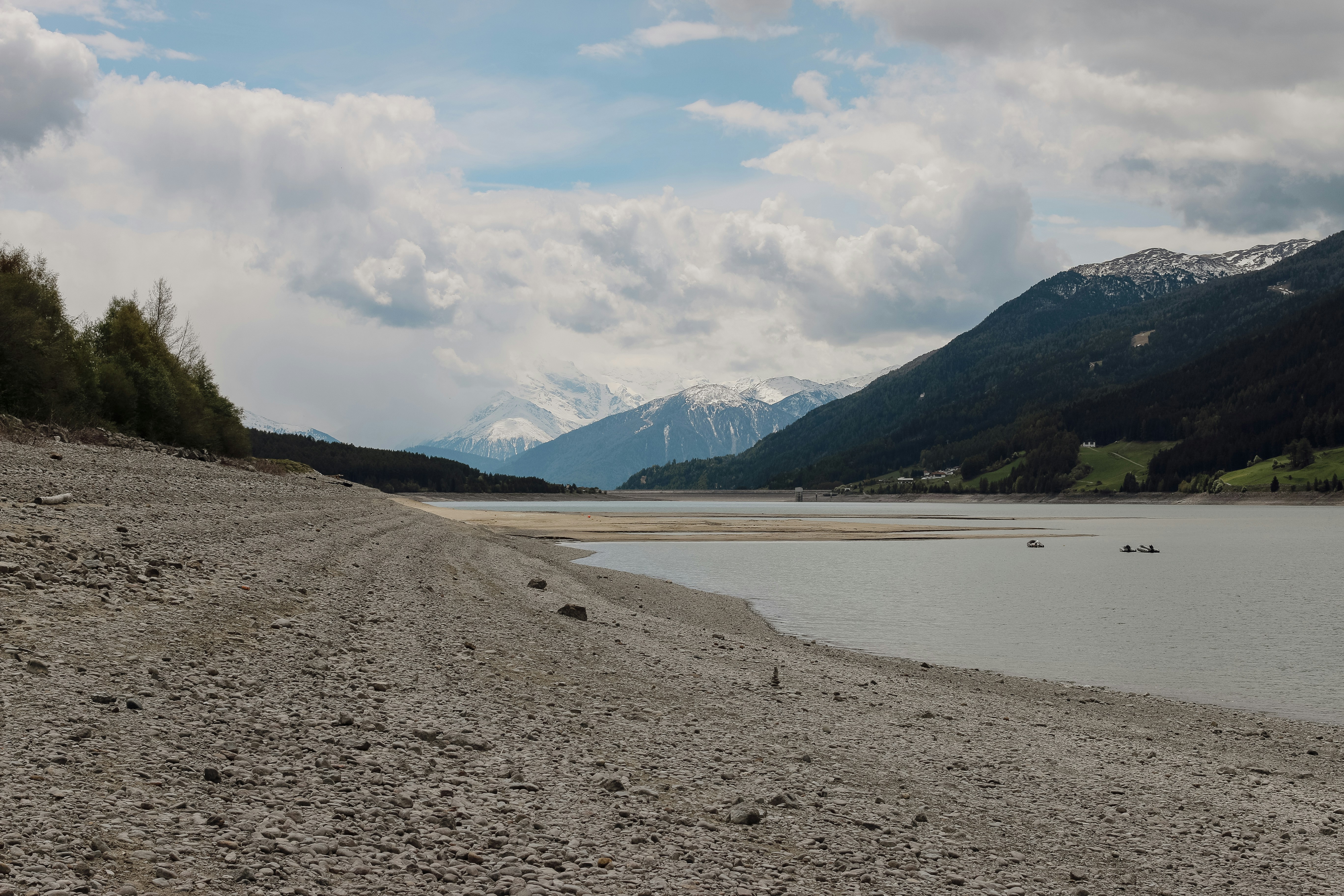 Glacial Fjord Ebb: Pebbles, Water, and Distant Snowcaps