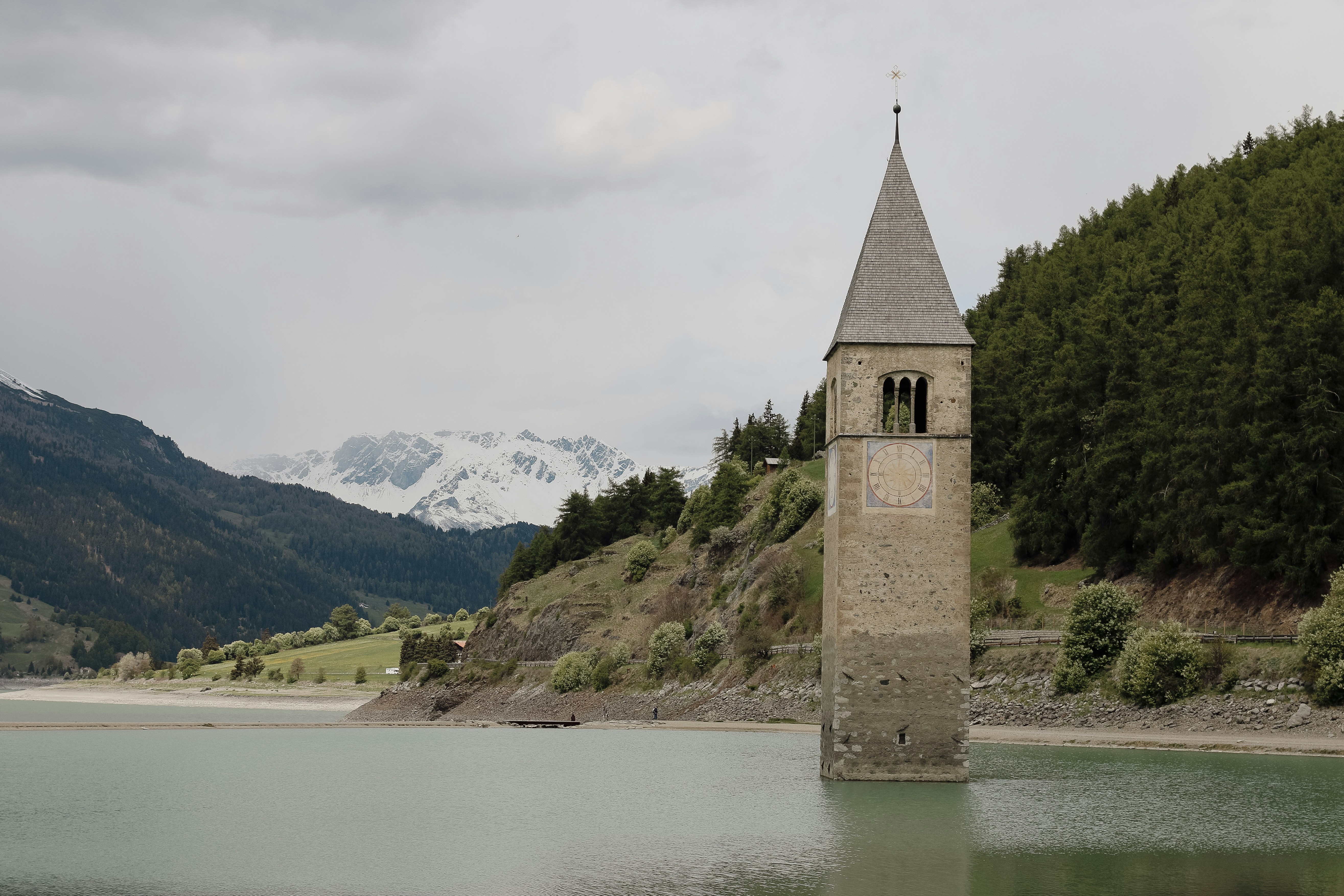 Tower in the Lake: A solitary clifftop bell tower rising from calm waters