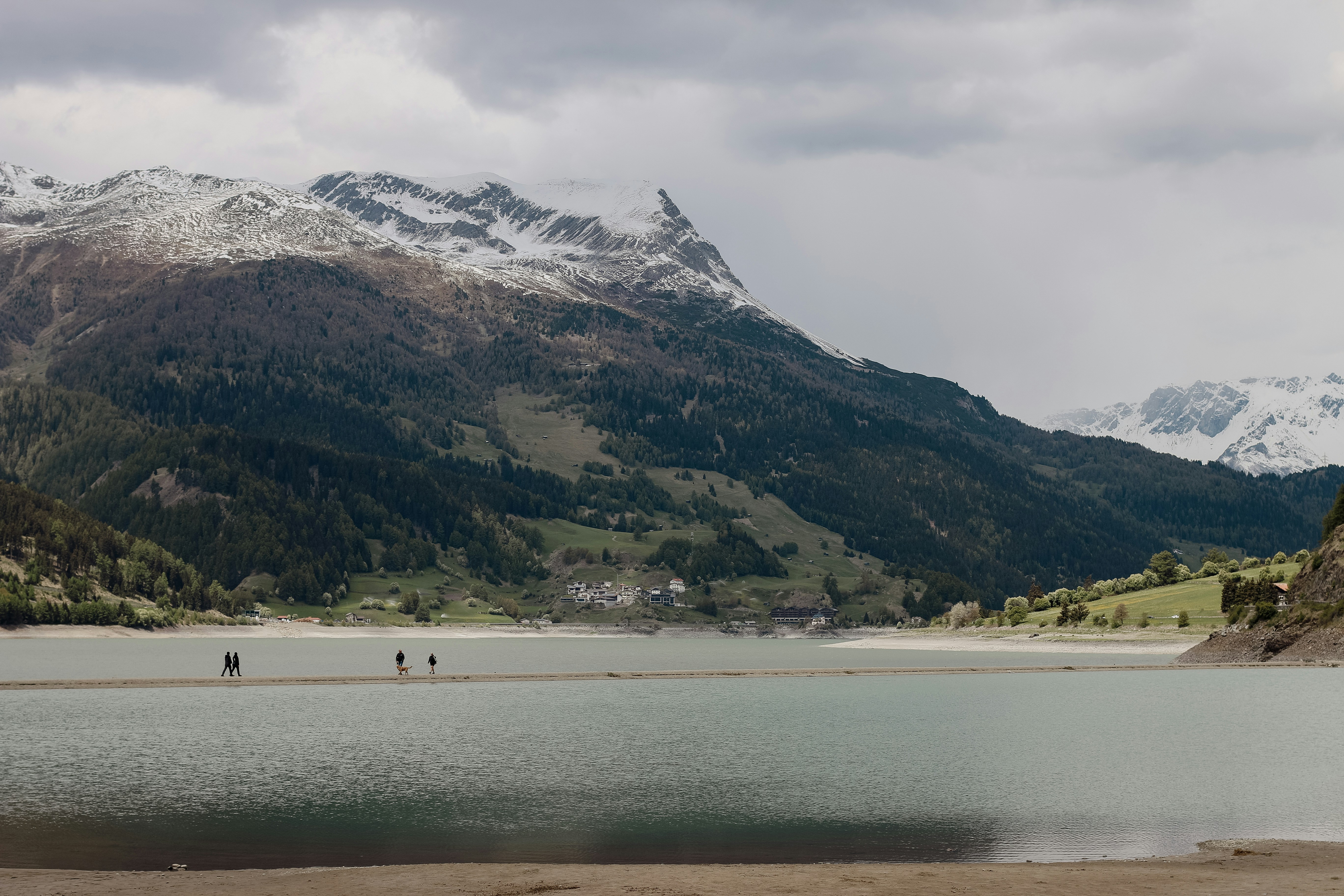 Snow-dusted peaks over a tranquil alpine lake