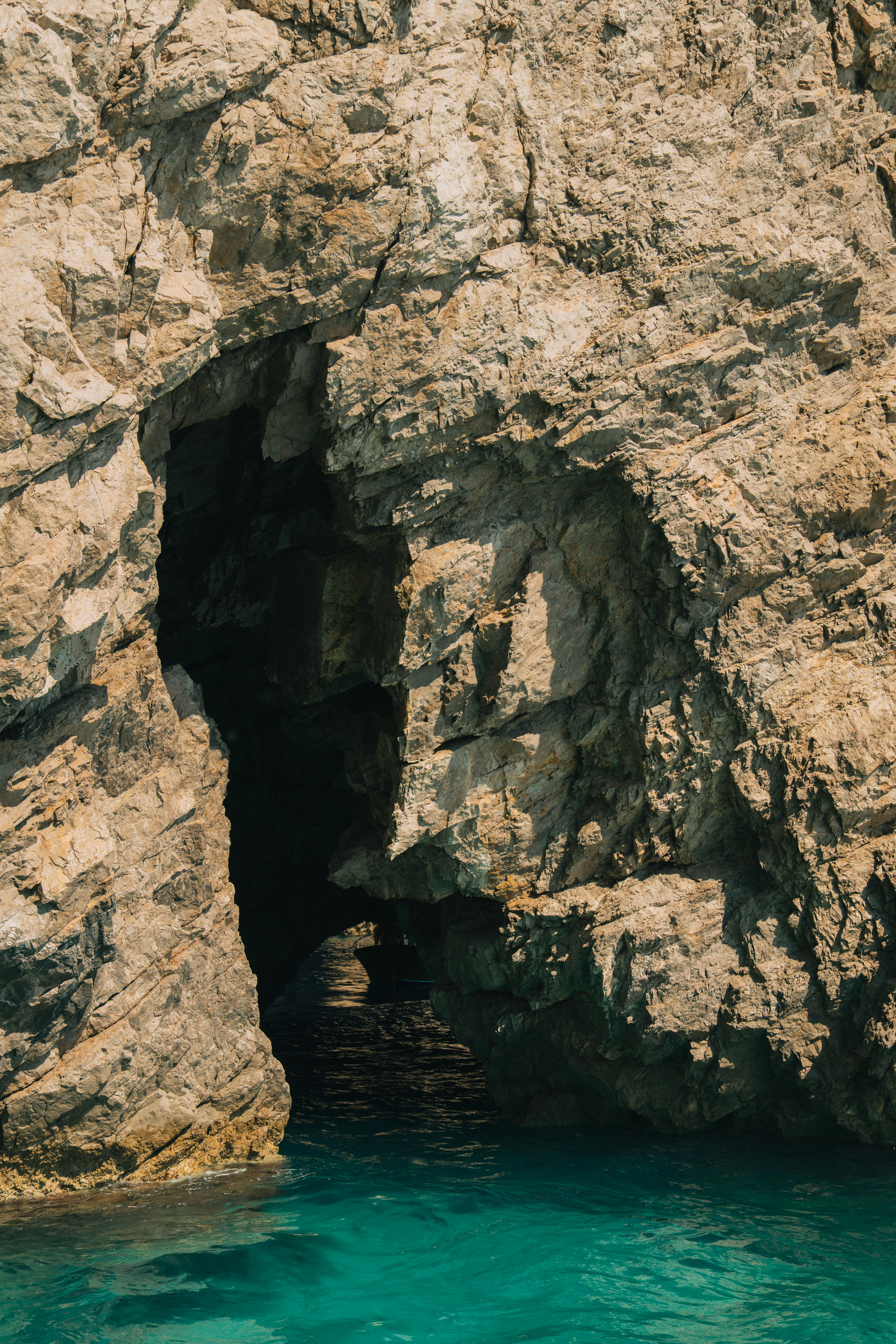 Emerald Tide Pierced by a Sea-Cave Gap