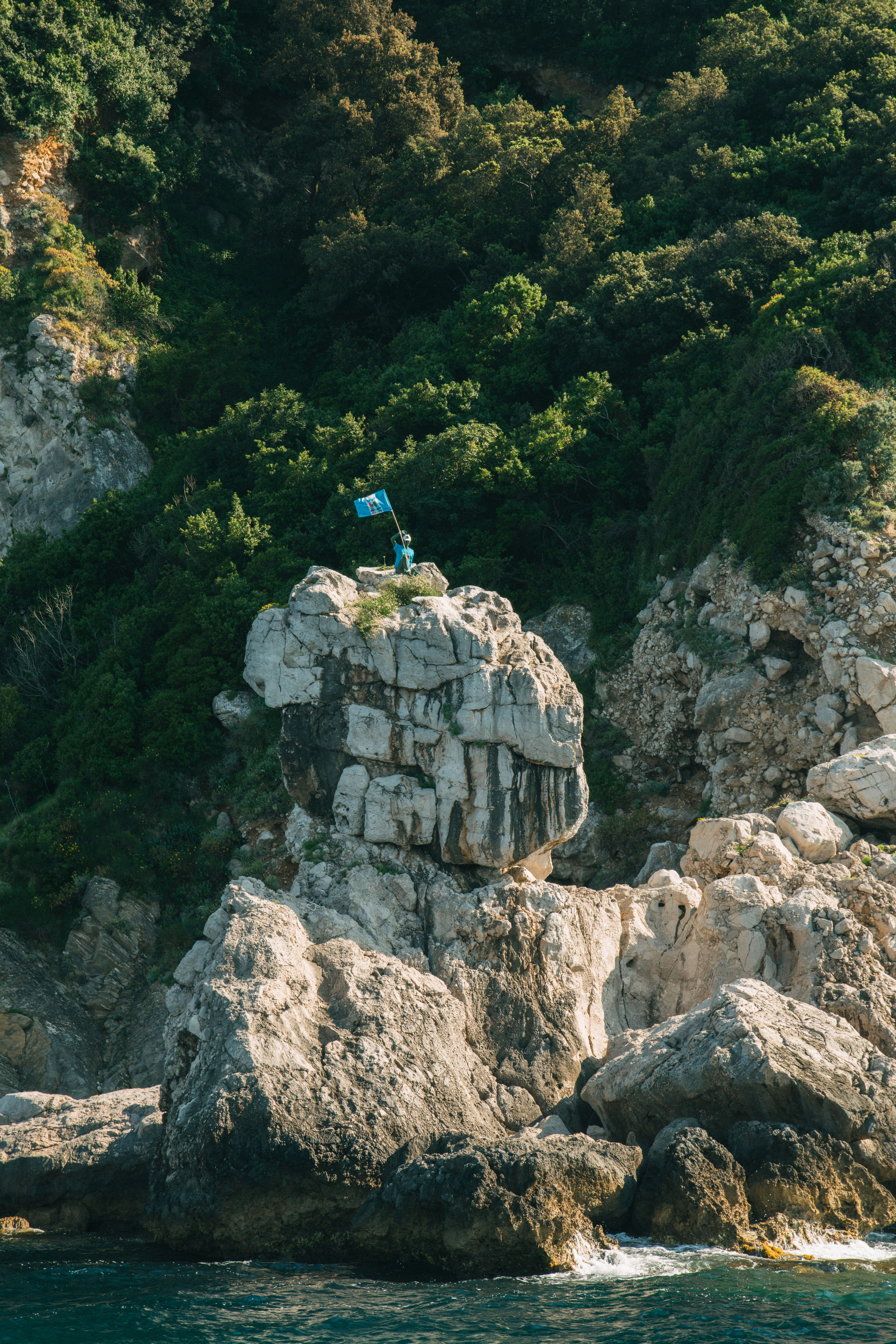 Flag on the Peak: A Lone Outcrop Watcher
