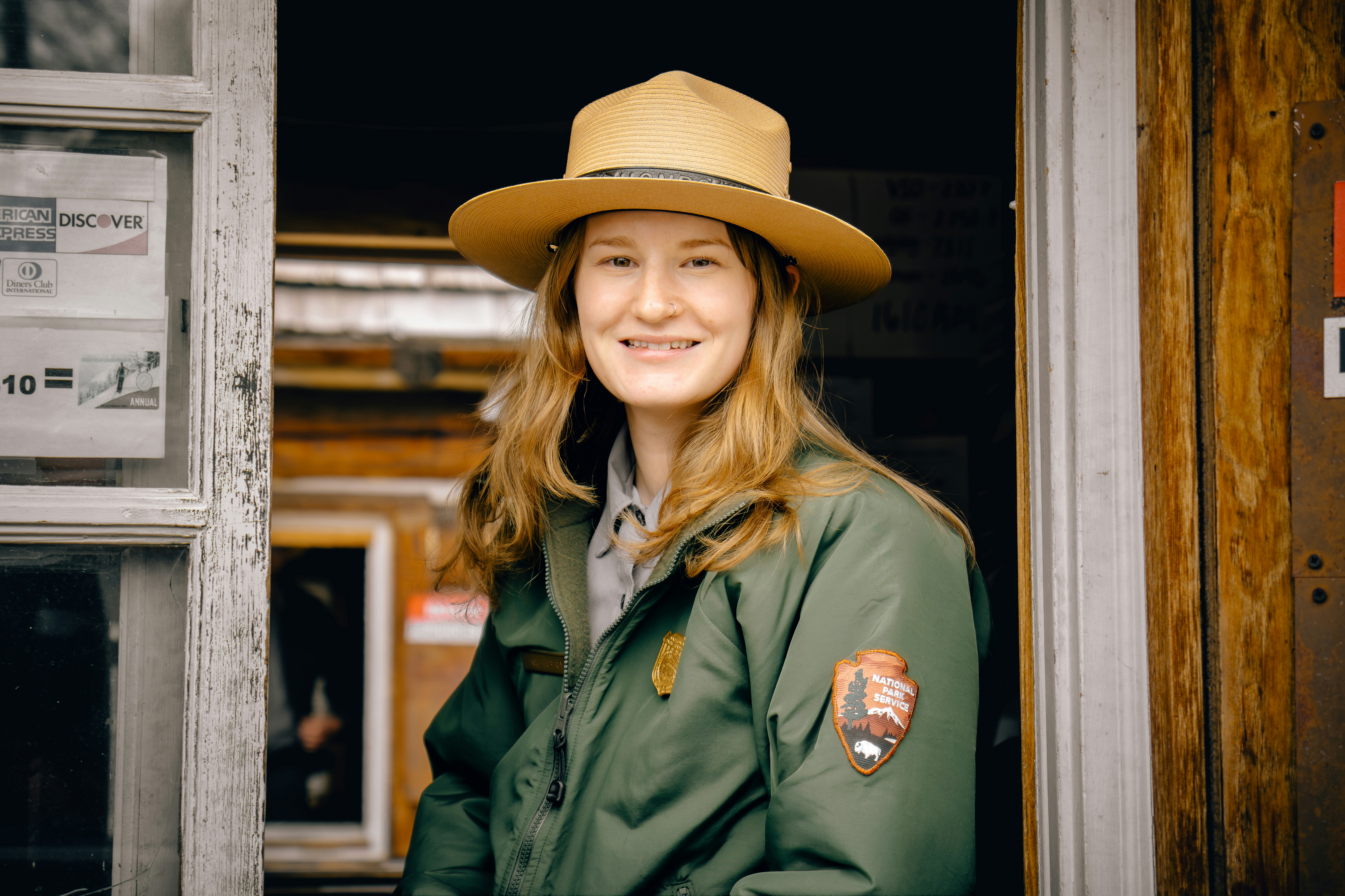 Smiling New Yorker at the Threshold of a Quiet Station