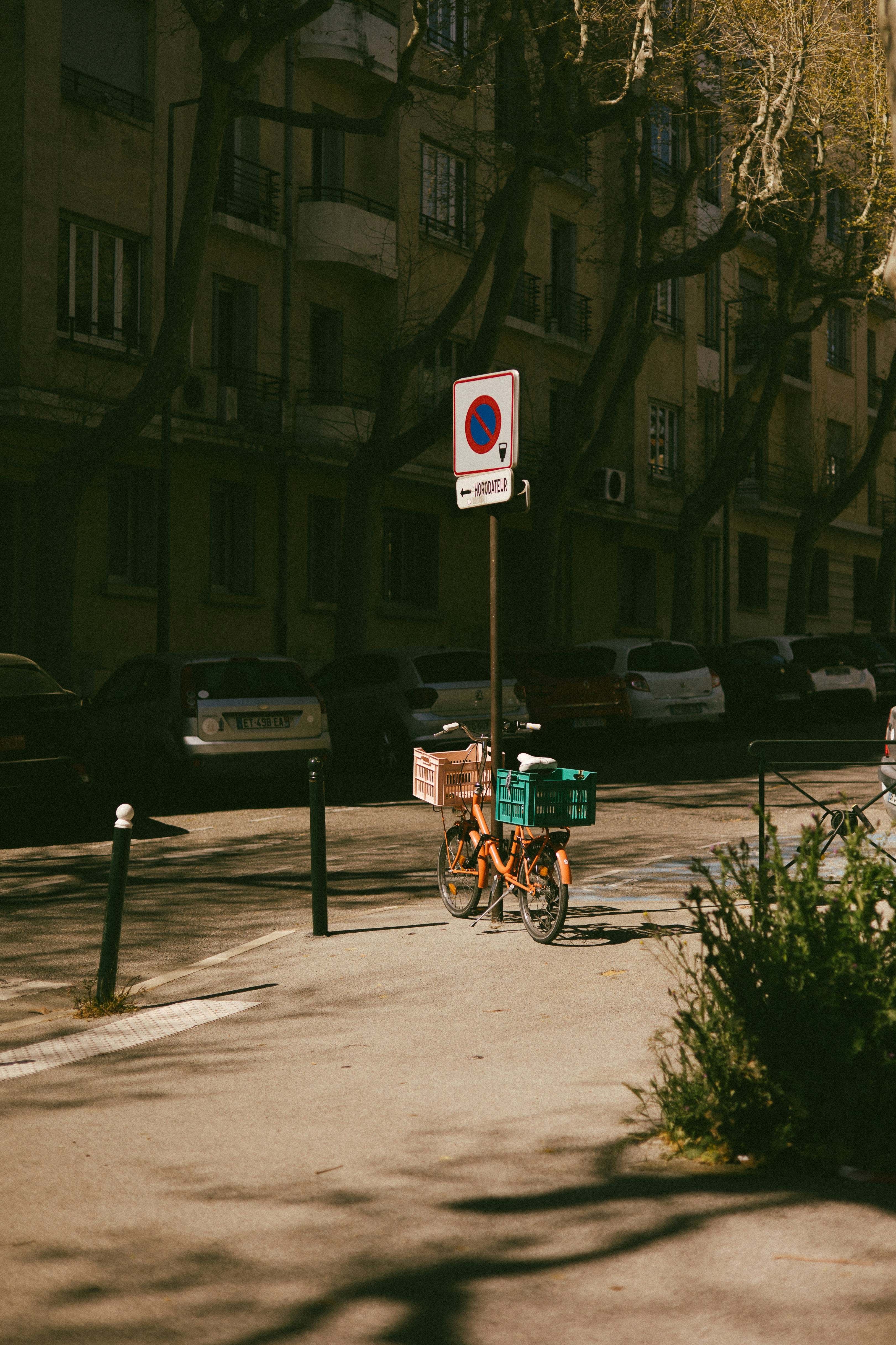 Bike with Green Crates in a Quiet Urban Courtyard