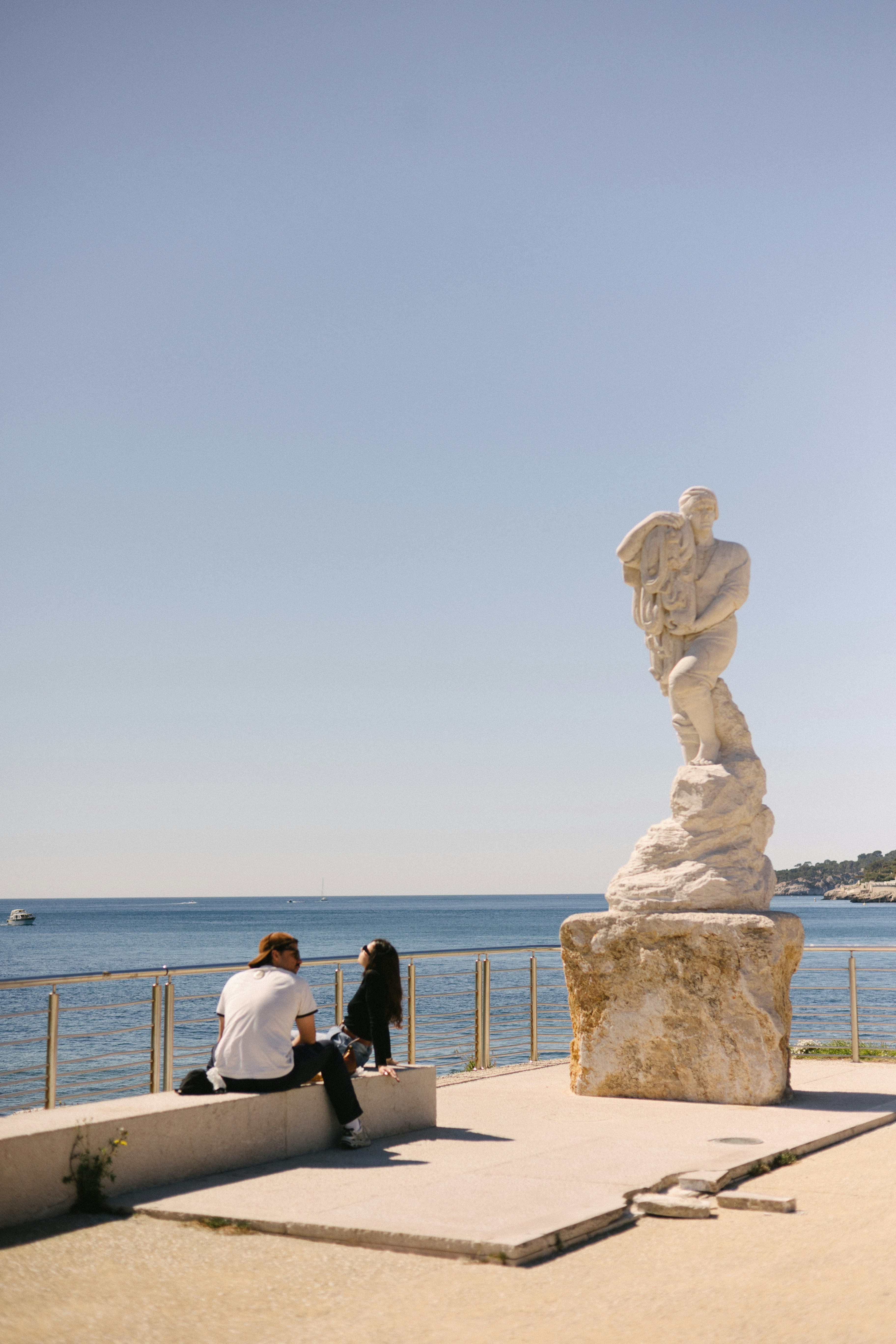 Seaside Conversation by the Sculpted Sentinel