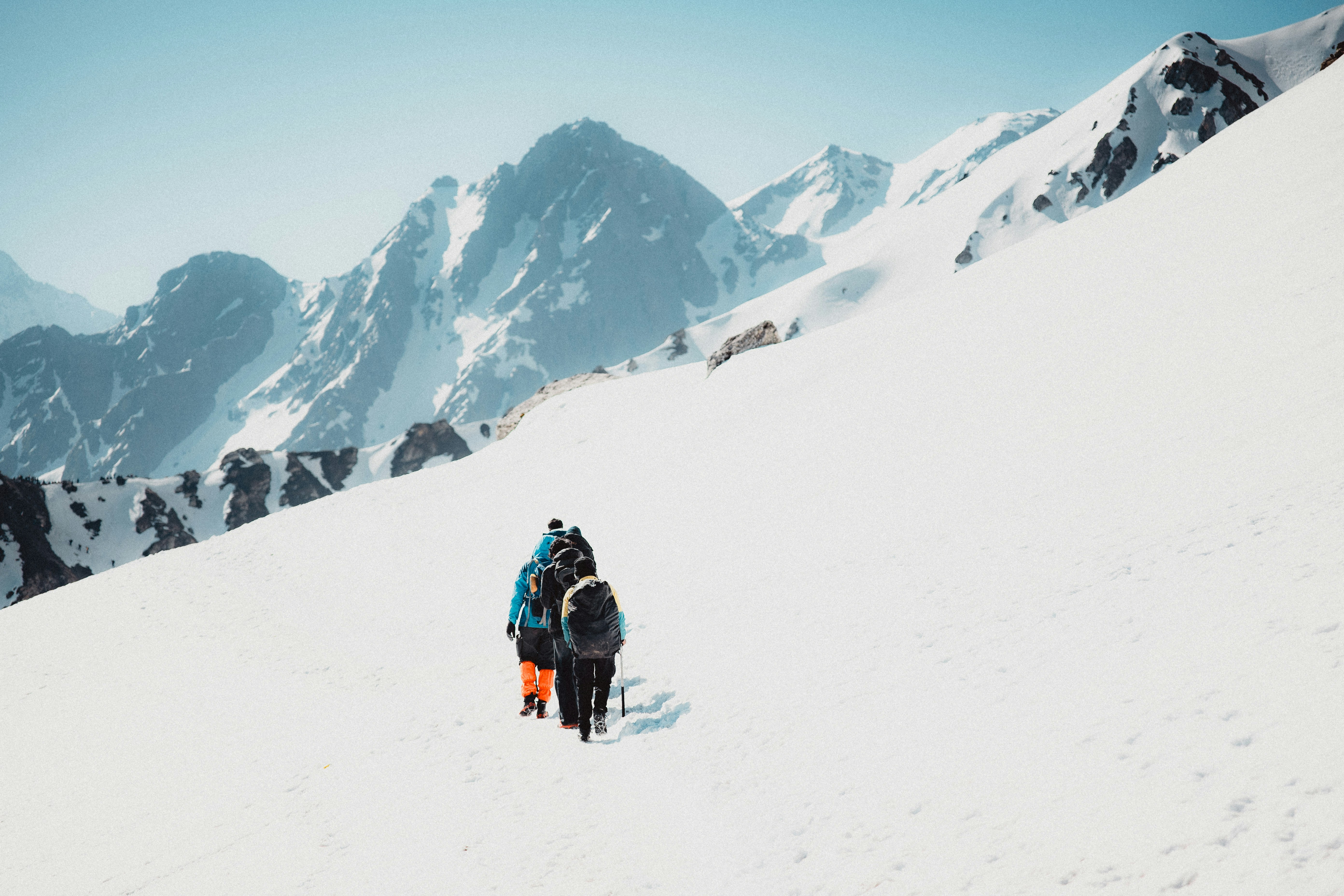 Triumph on the Slope: Climbers Against a Snowfield Backdrop