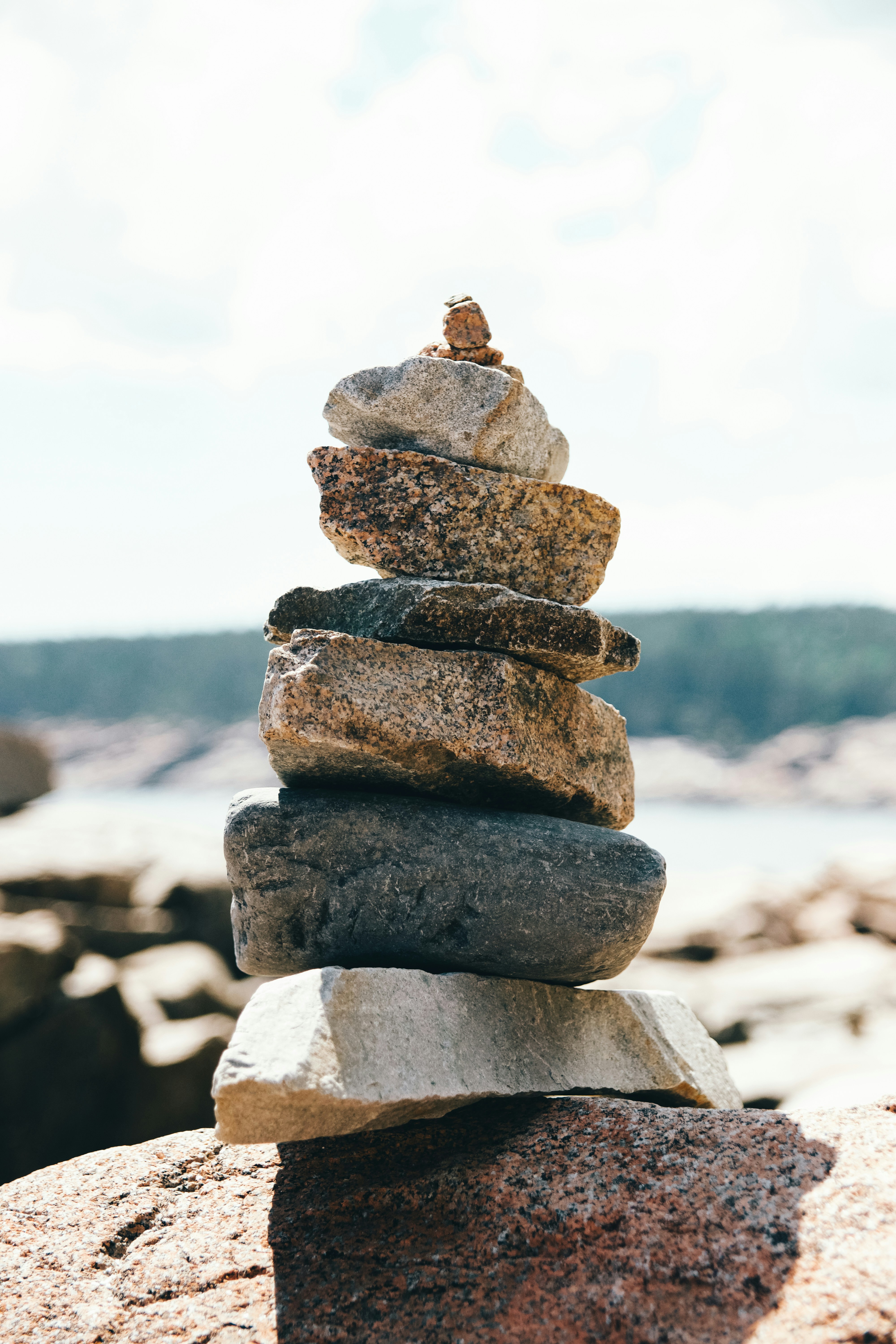 Balanced Cairn of Coastal Stones Elevating the Quiet Horizon