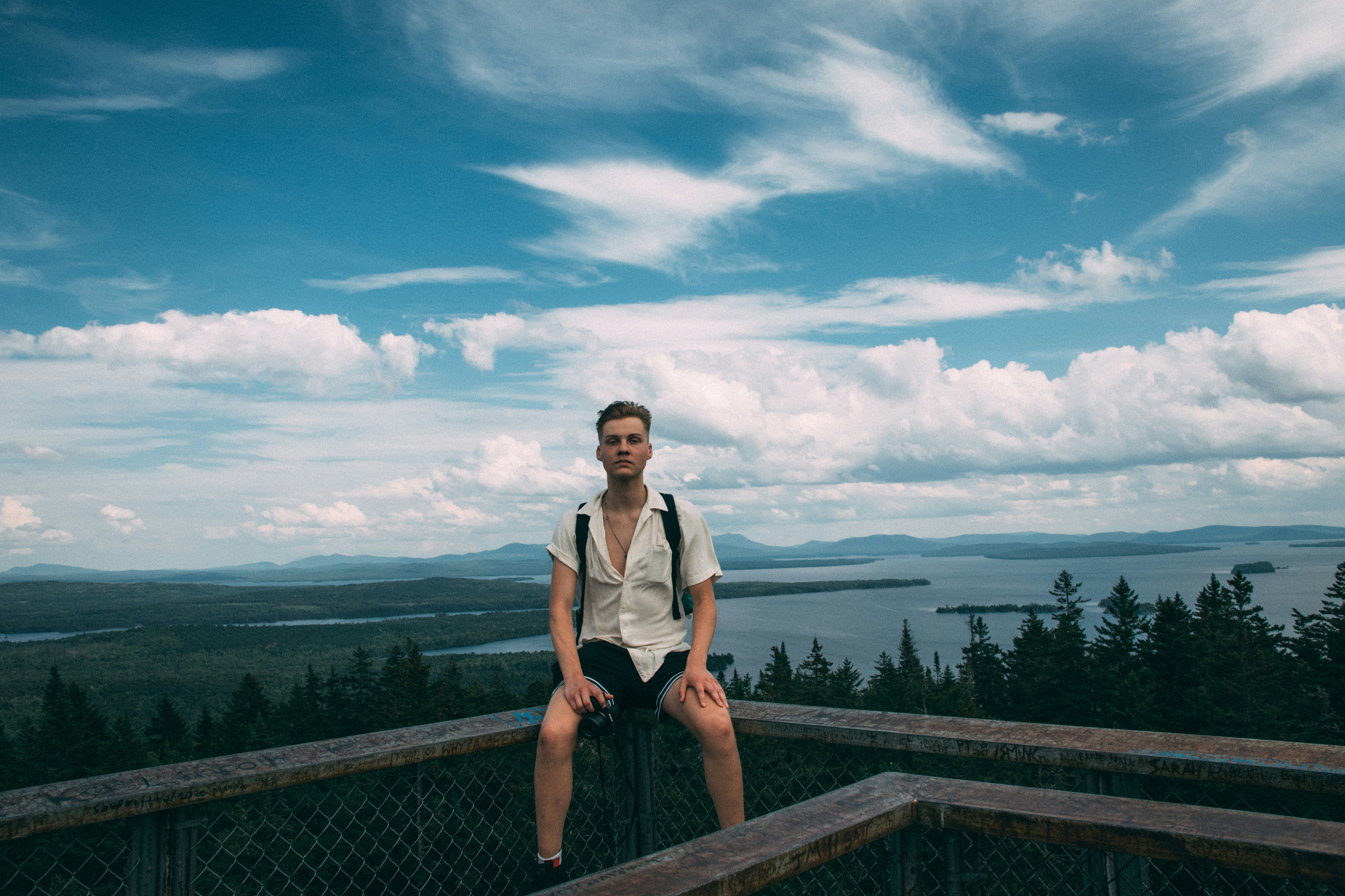 On the overlook: solitary climber amid a sea of blue sky