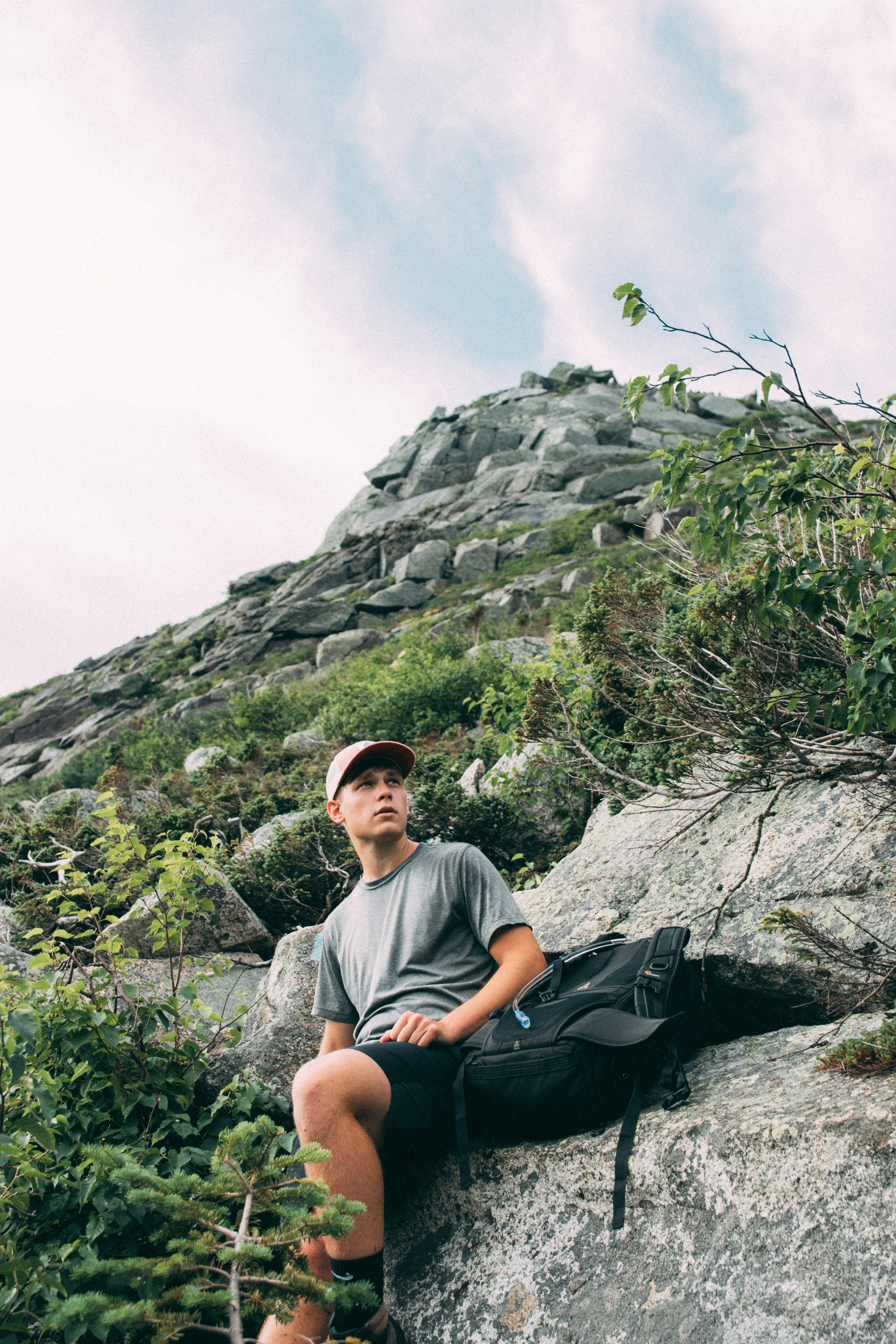 Hiker Pauses on Granite Ridge Under Open Sky