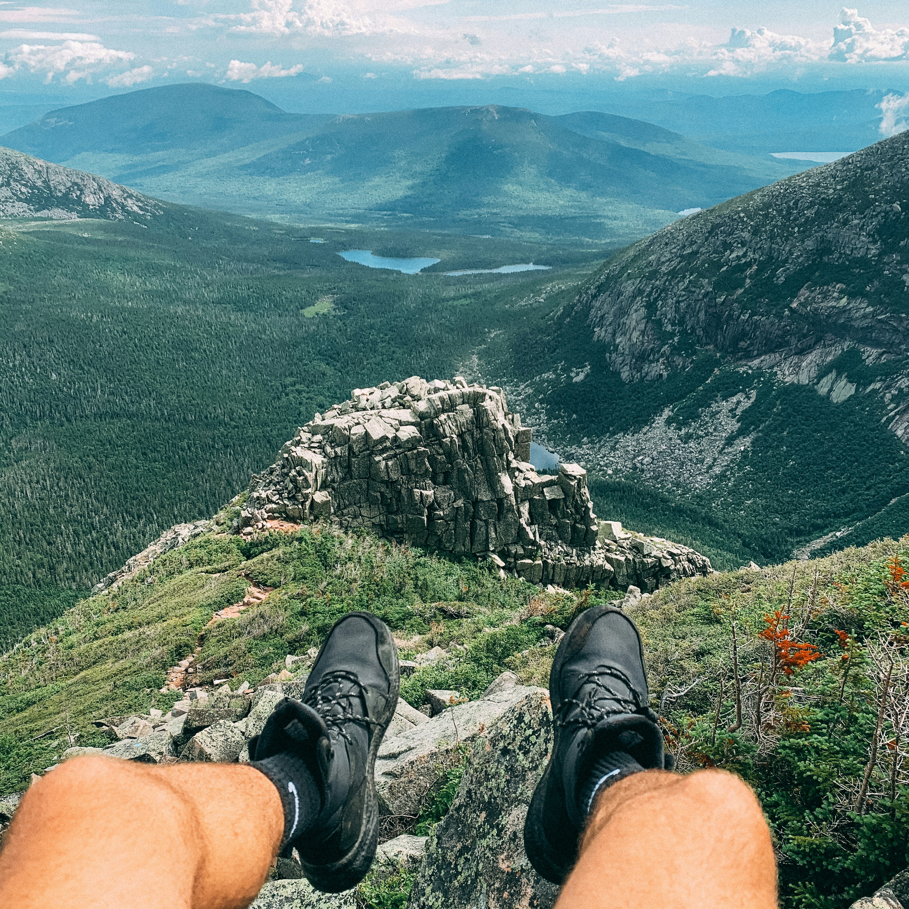 Trail-Top View: Shoes Rest on Ridge with Valley and Lakes Beyond
