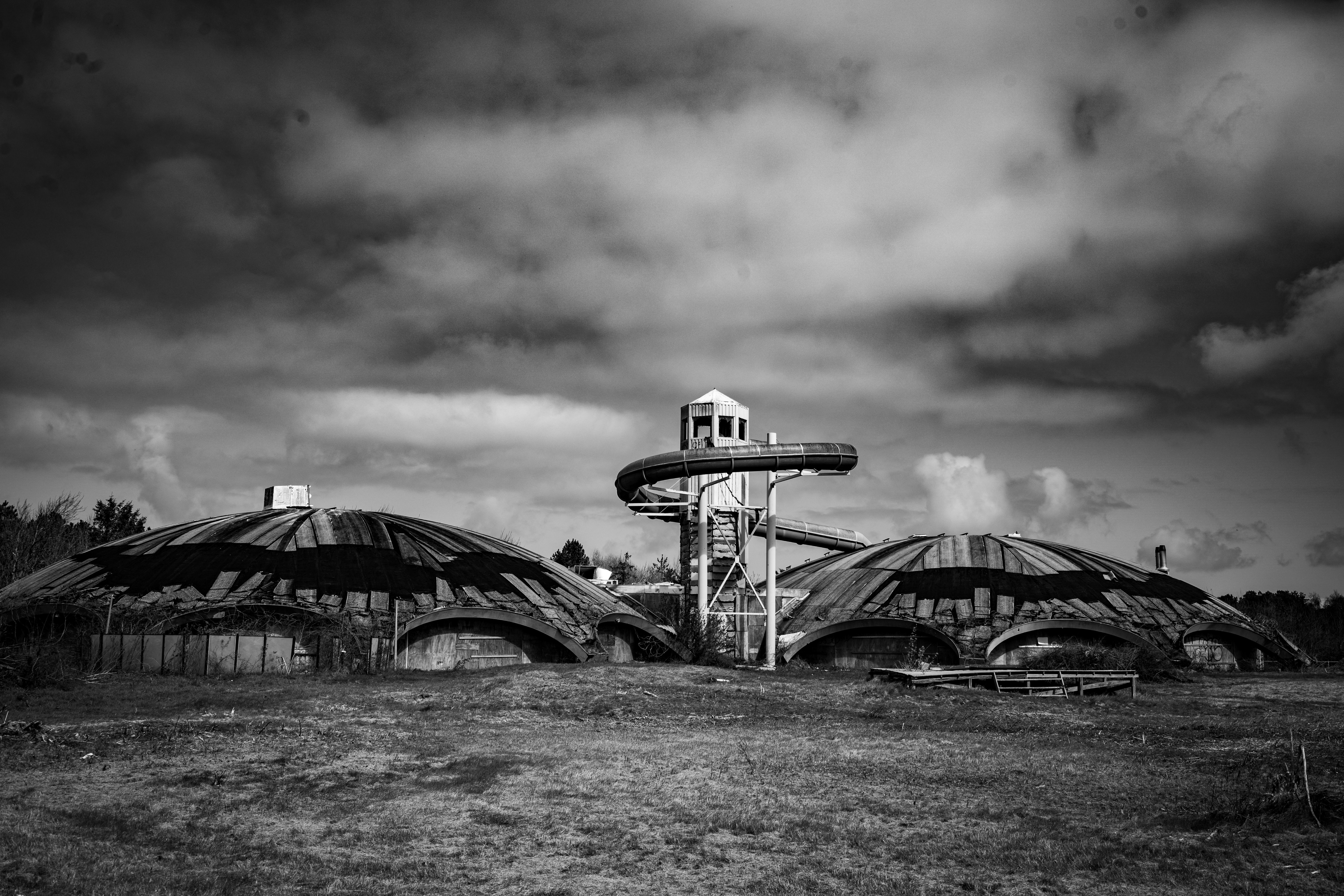 Deserted Water Park in Monochrome: A Quiet, Somber Play Between Structure and Sky