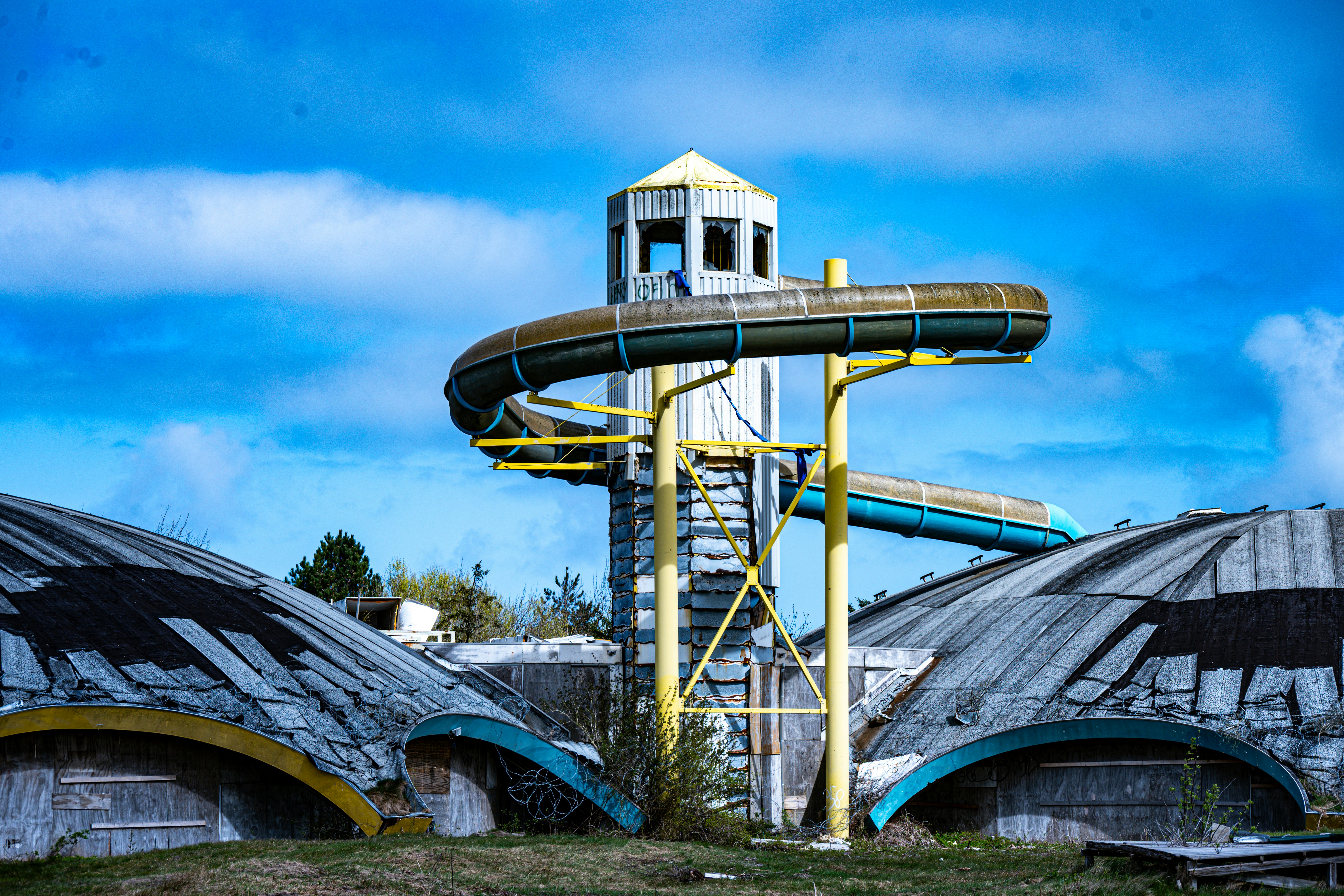 Dilapidated Waterslide Tower Rising from Sunken Dome Ruins
