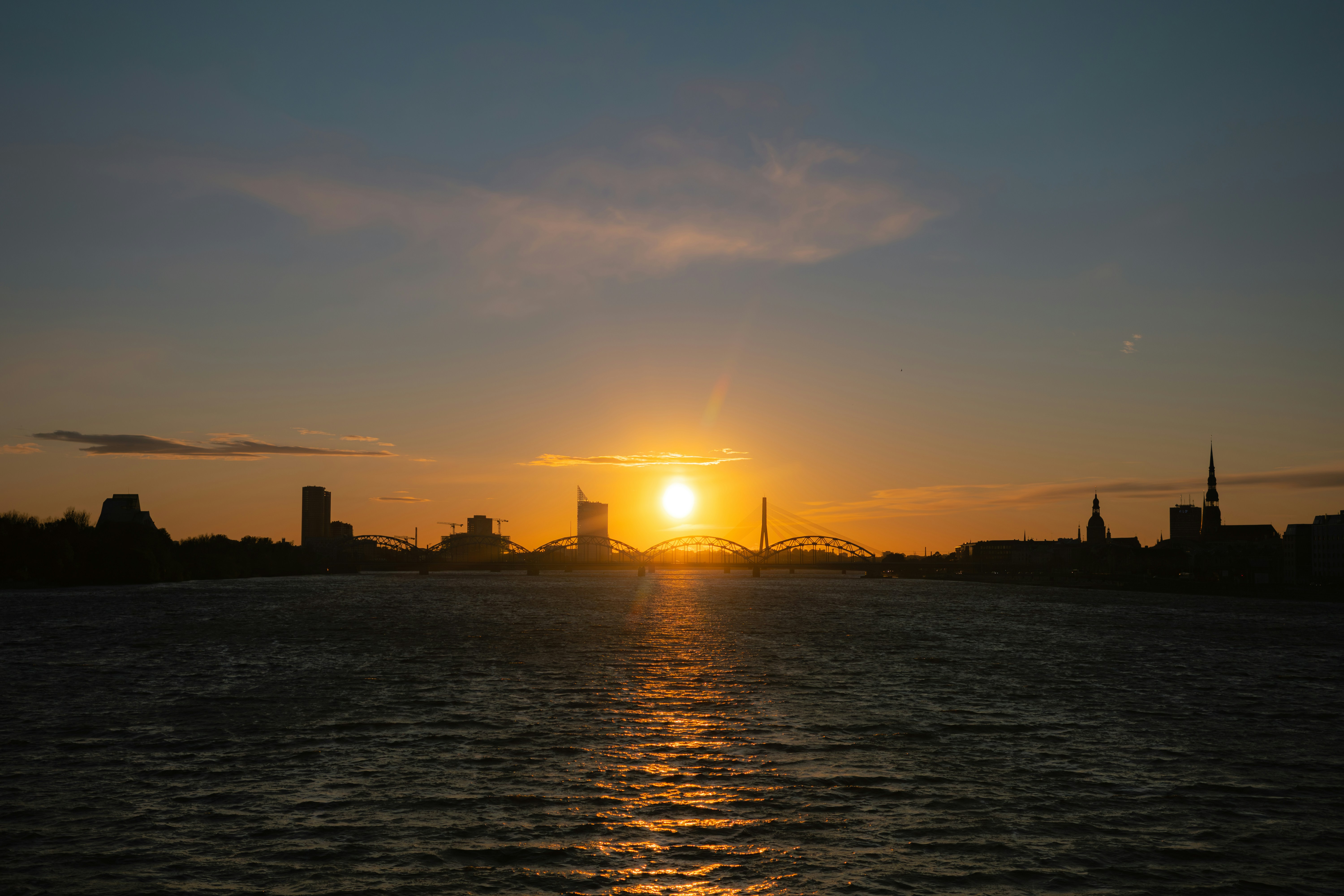 Sunset Over the River: City Silhouette at Golden Hour