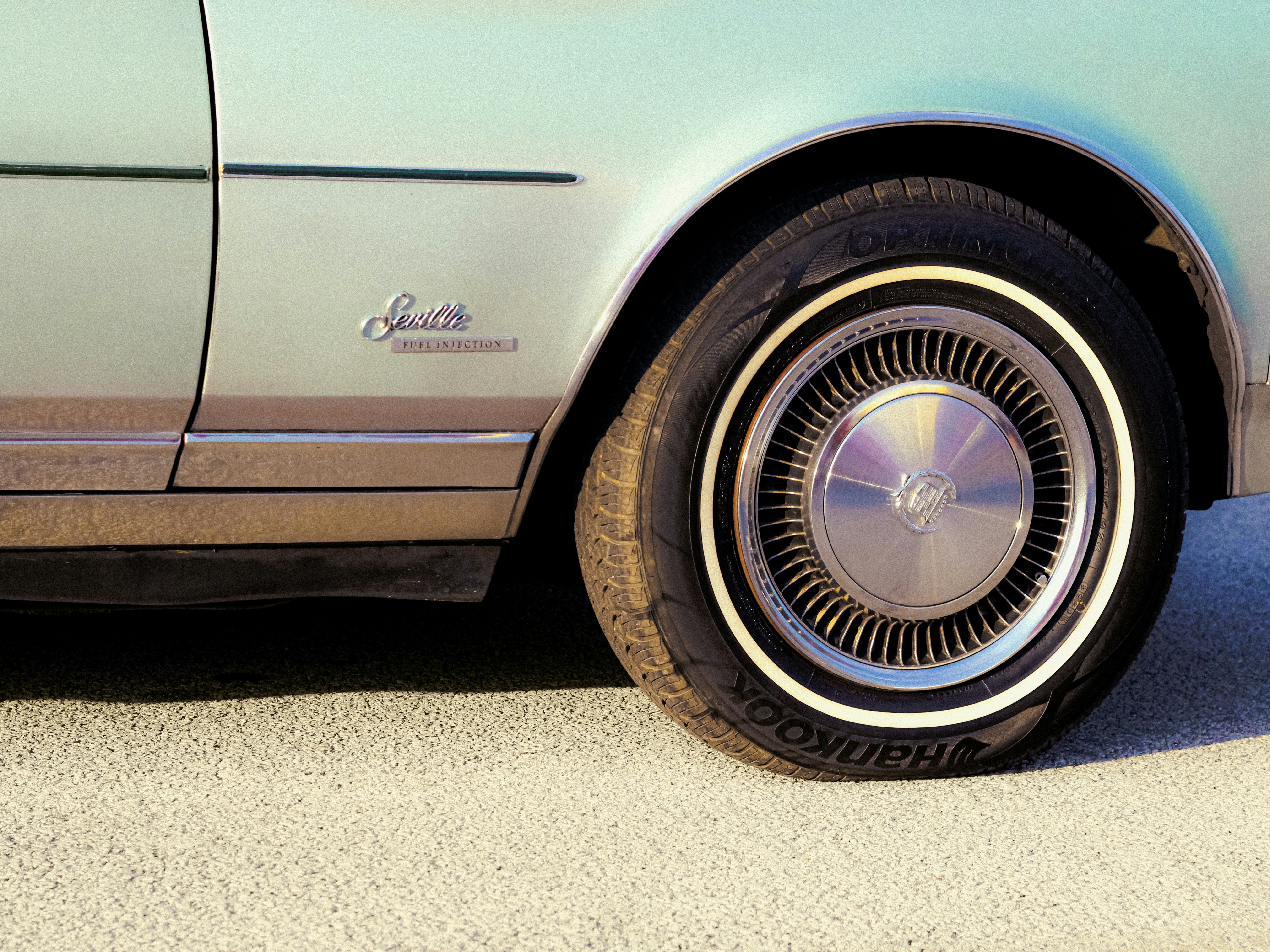 Chrome hubcap and Crest: a 1970s Chevy in soft sunlight