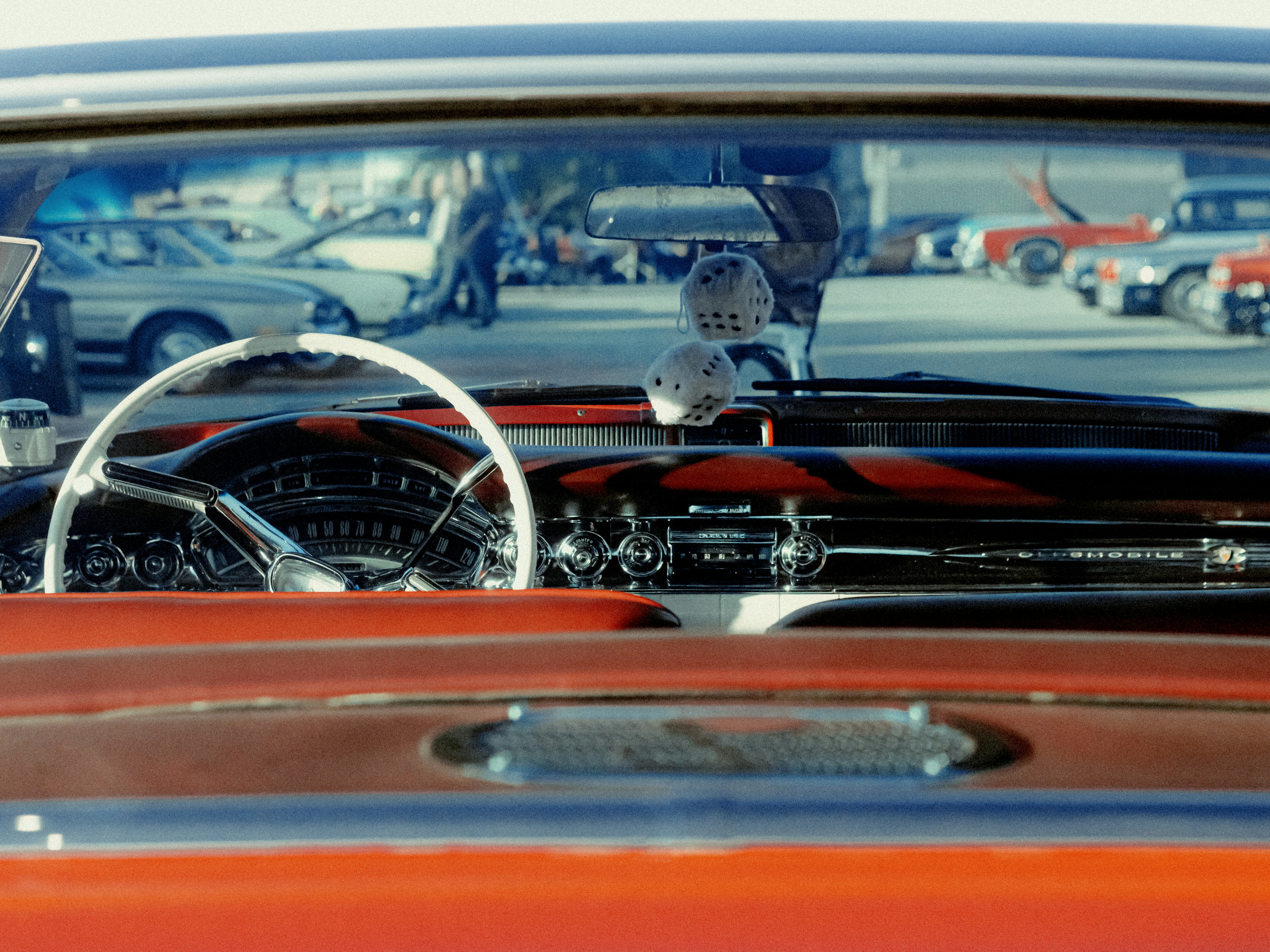 Vintage Red Dash: Classic Car Interior Through Windshield Glass