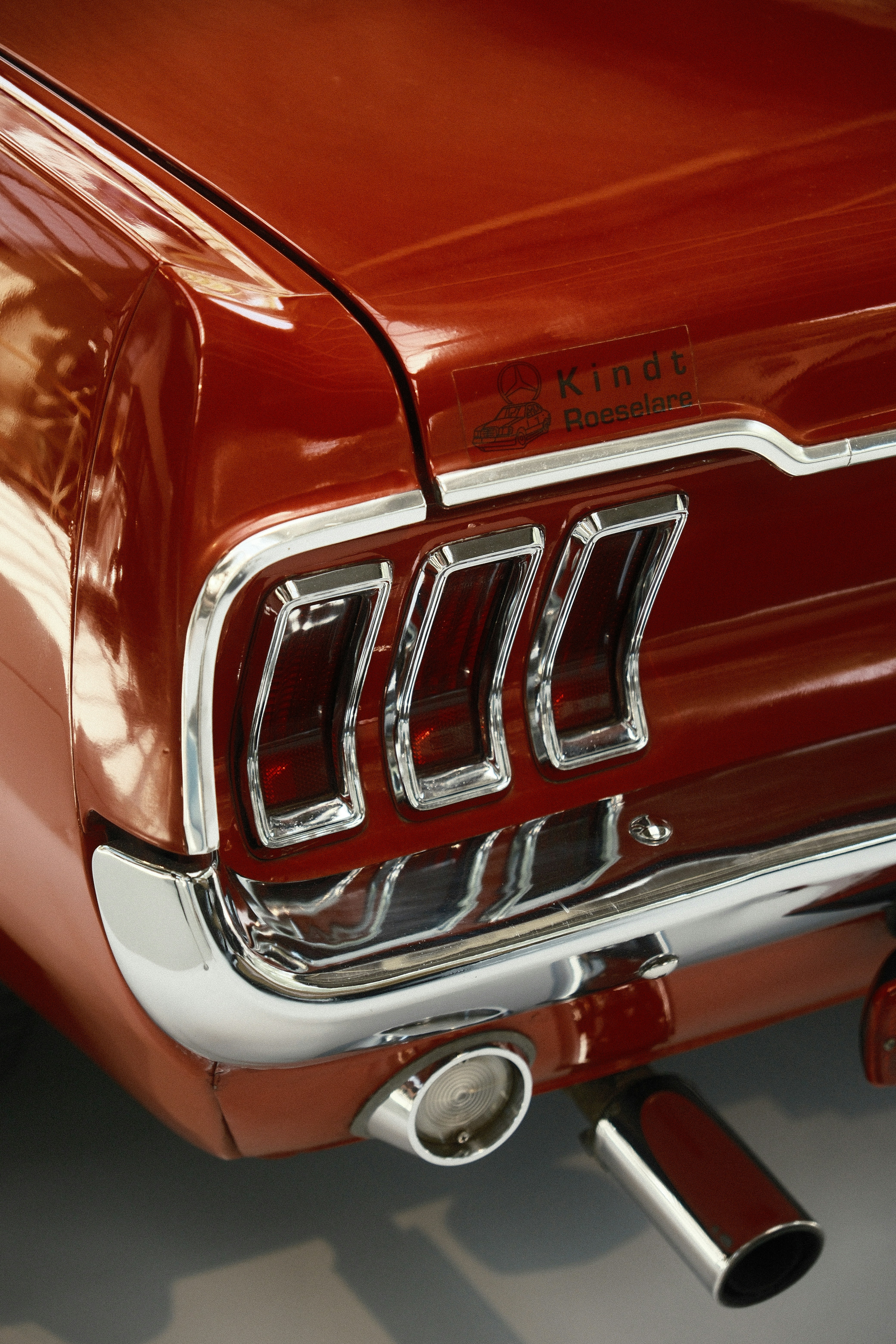 Chrome Reflections on a Vintage Muscle: The Back of a Fiery Rust Buick
