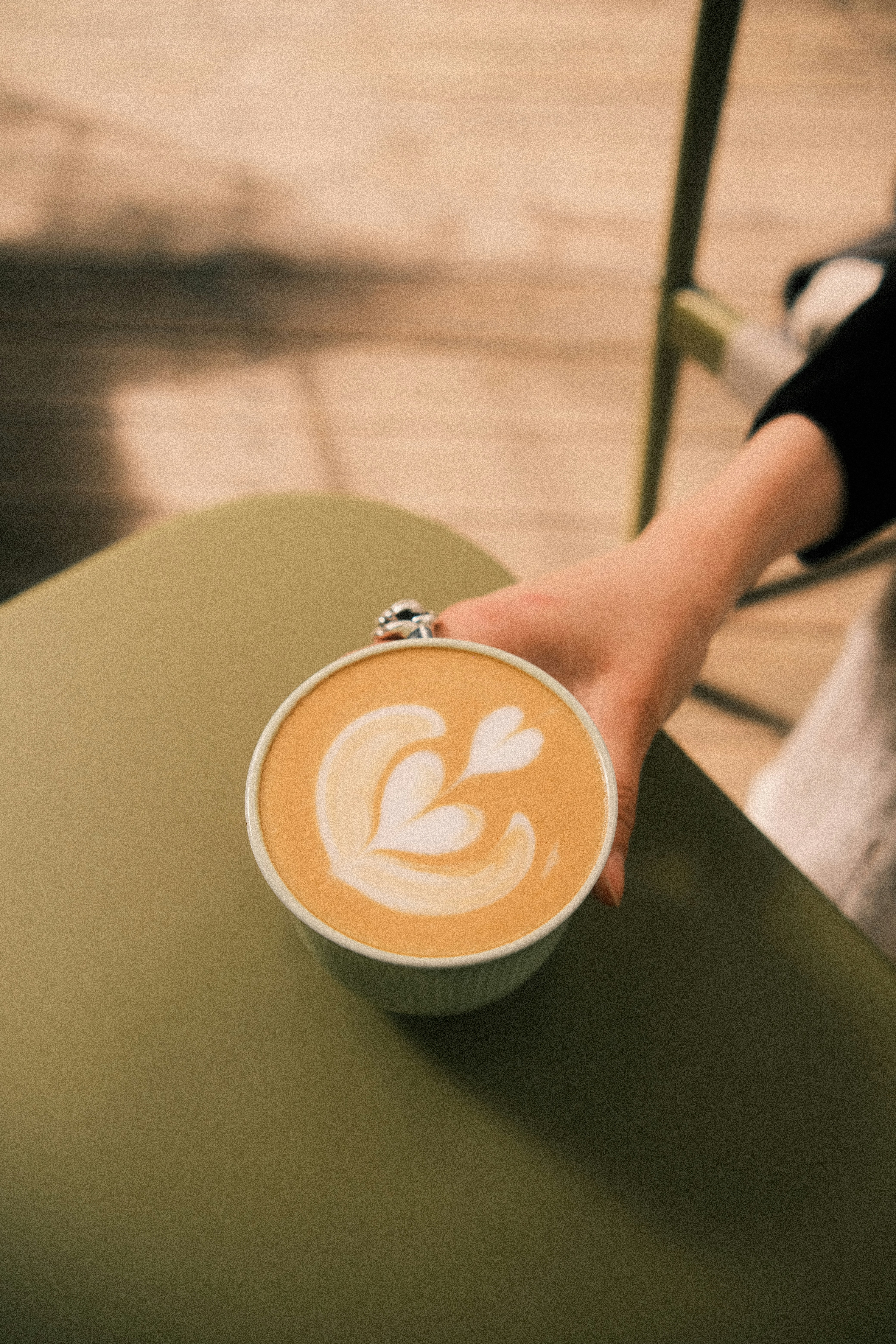 Latte Heartbeat: A Coffee Moment on Olive-Table Afternoon