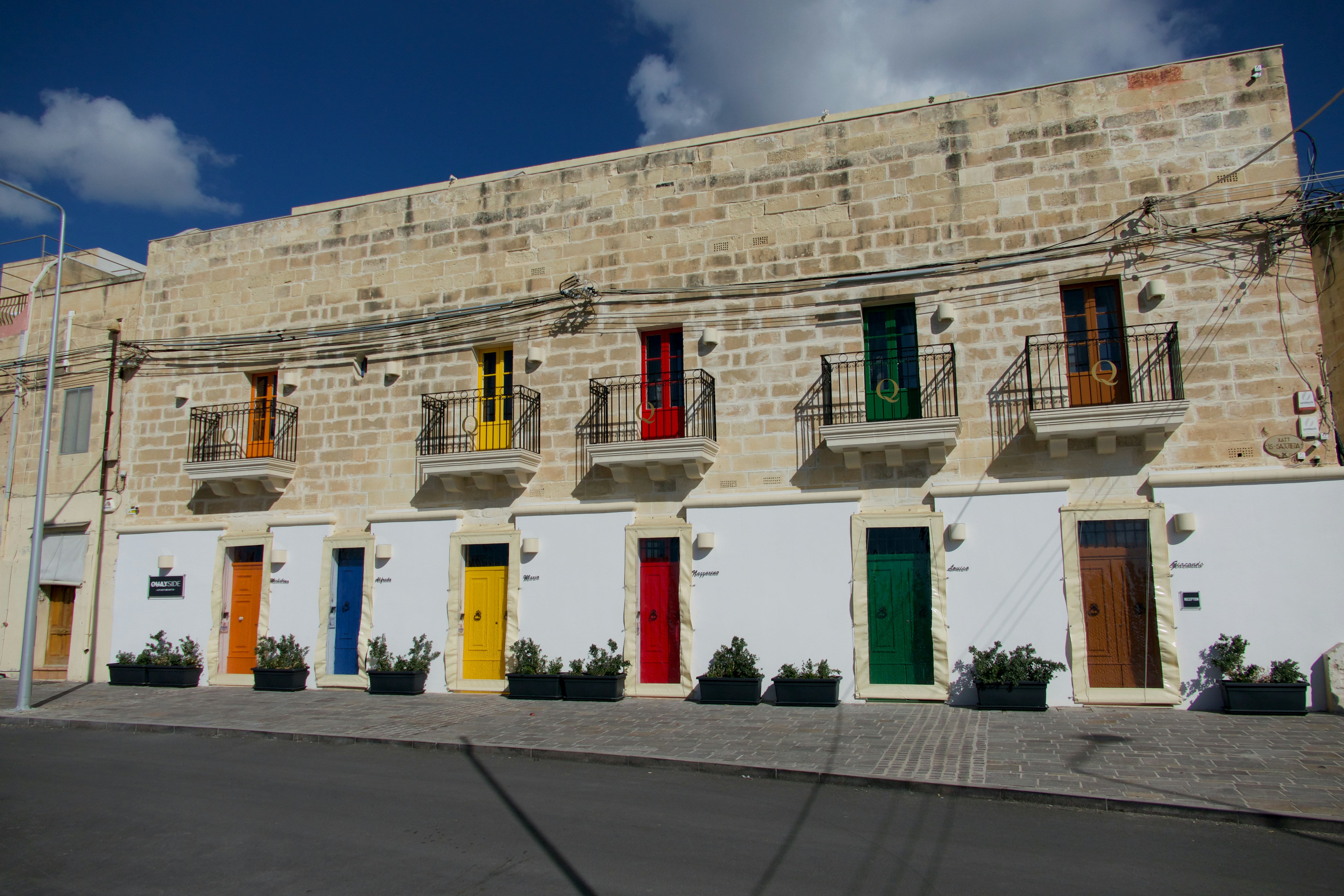Colorful Doors on a Sunlit Stone Facade
