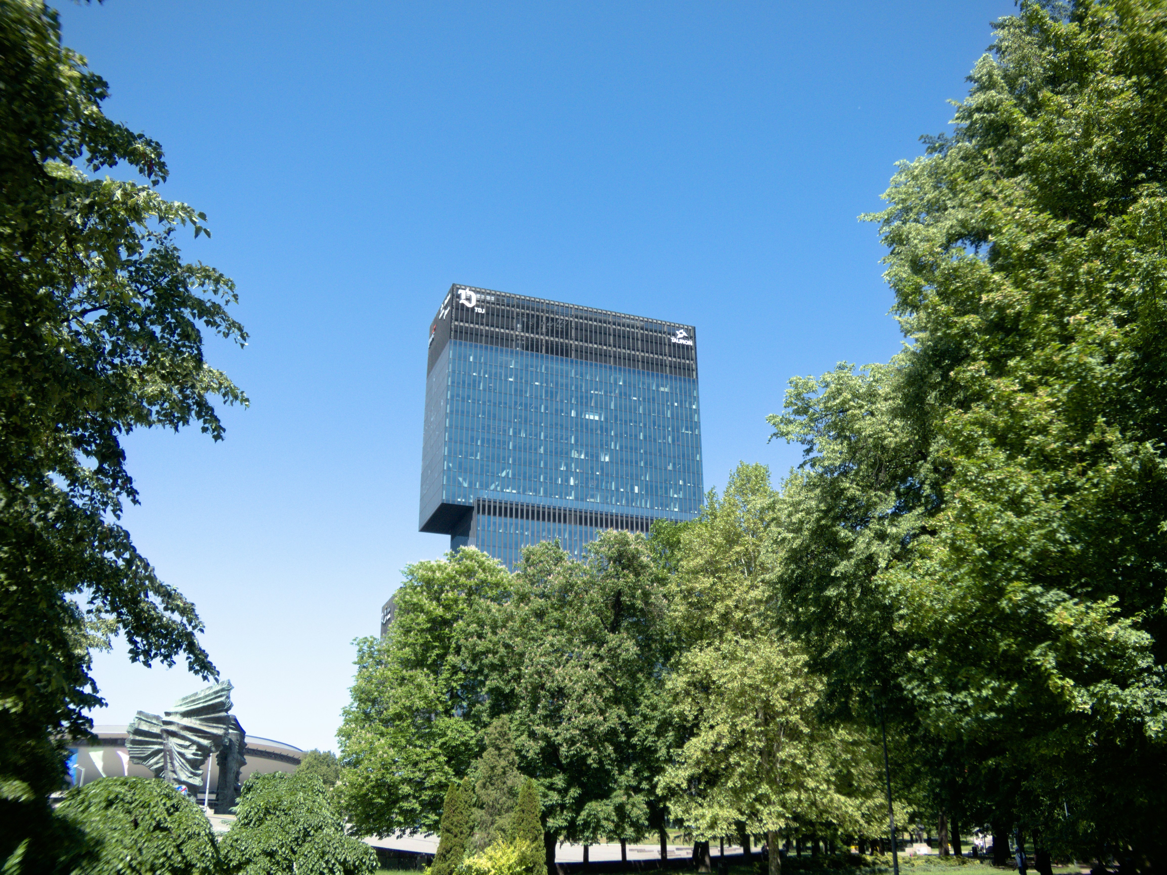 Urban Prism: The Glass Cube Rising Above The Trees