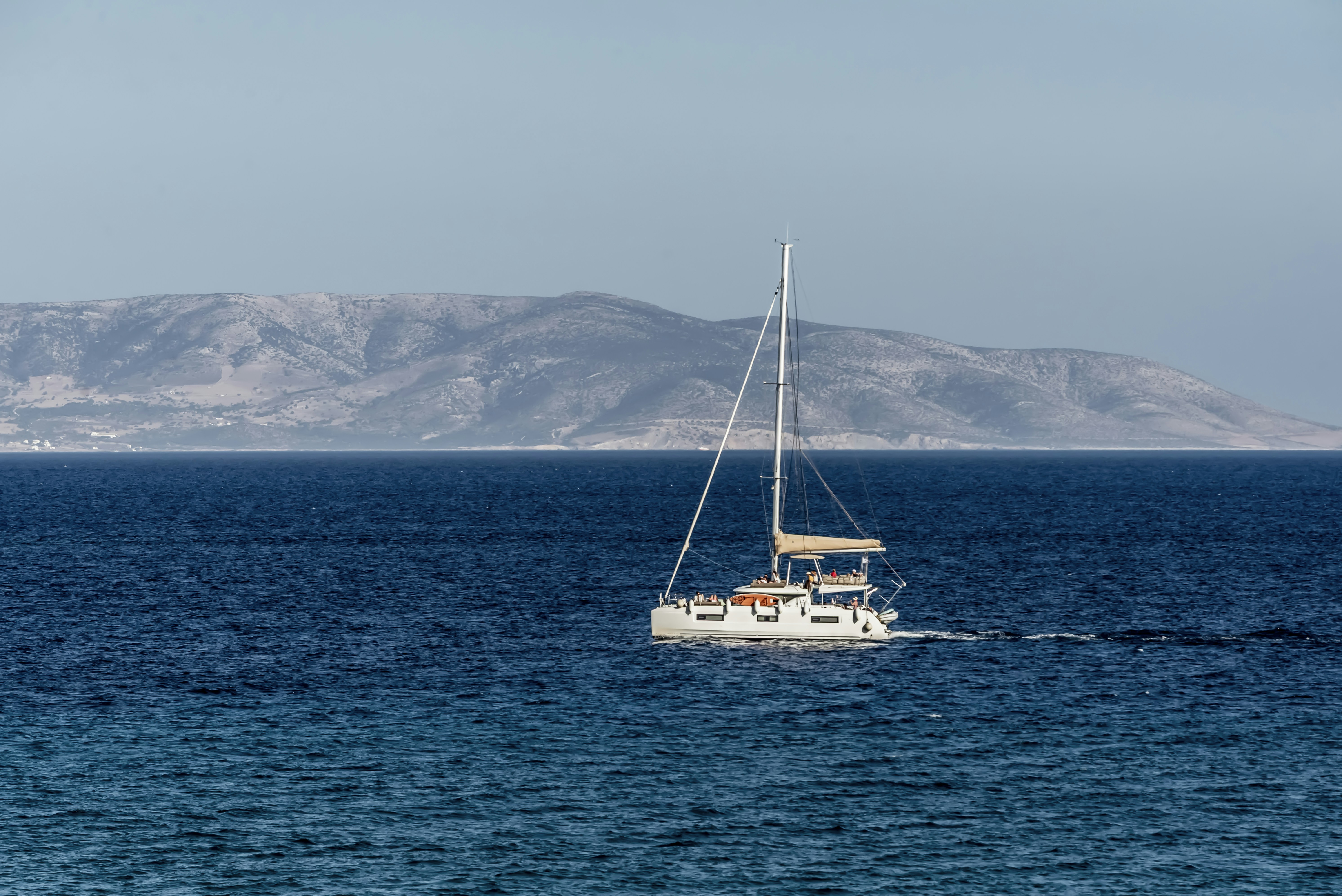 Solitary Sloop on Quiet Blue Expanse