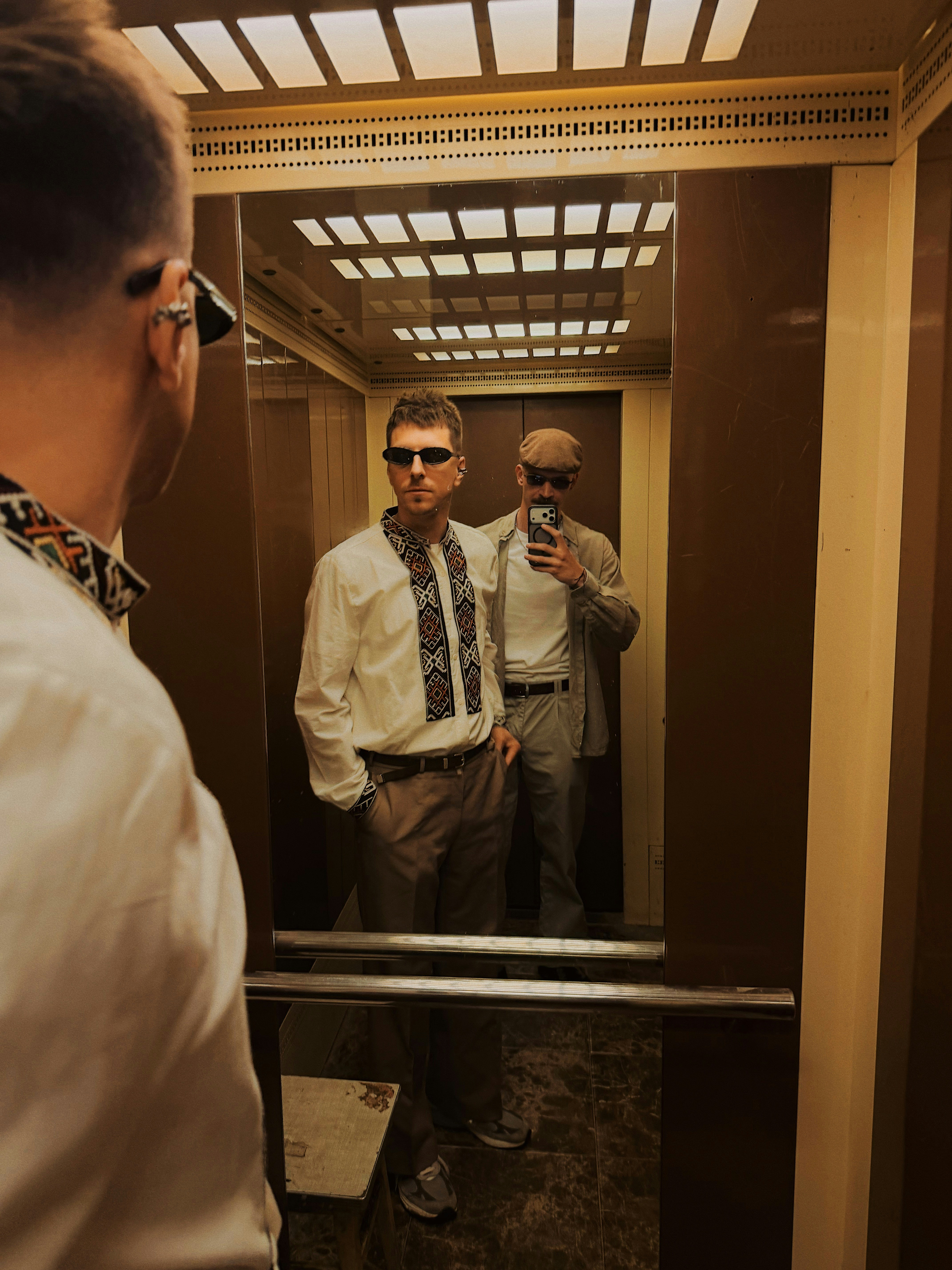Mirror Echoes: A Retro Style Duo in an Elevator