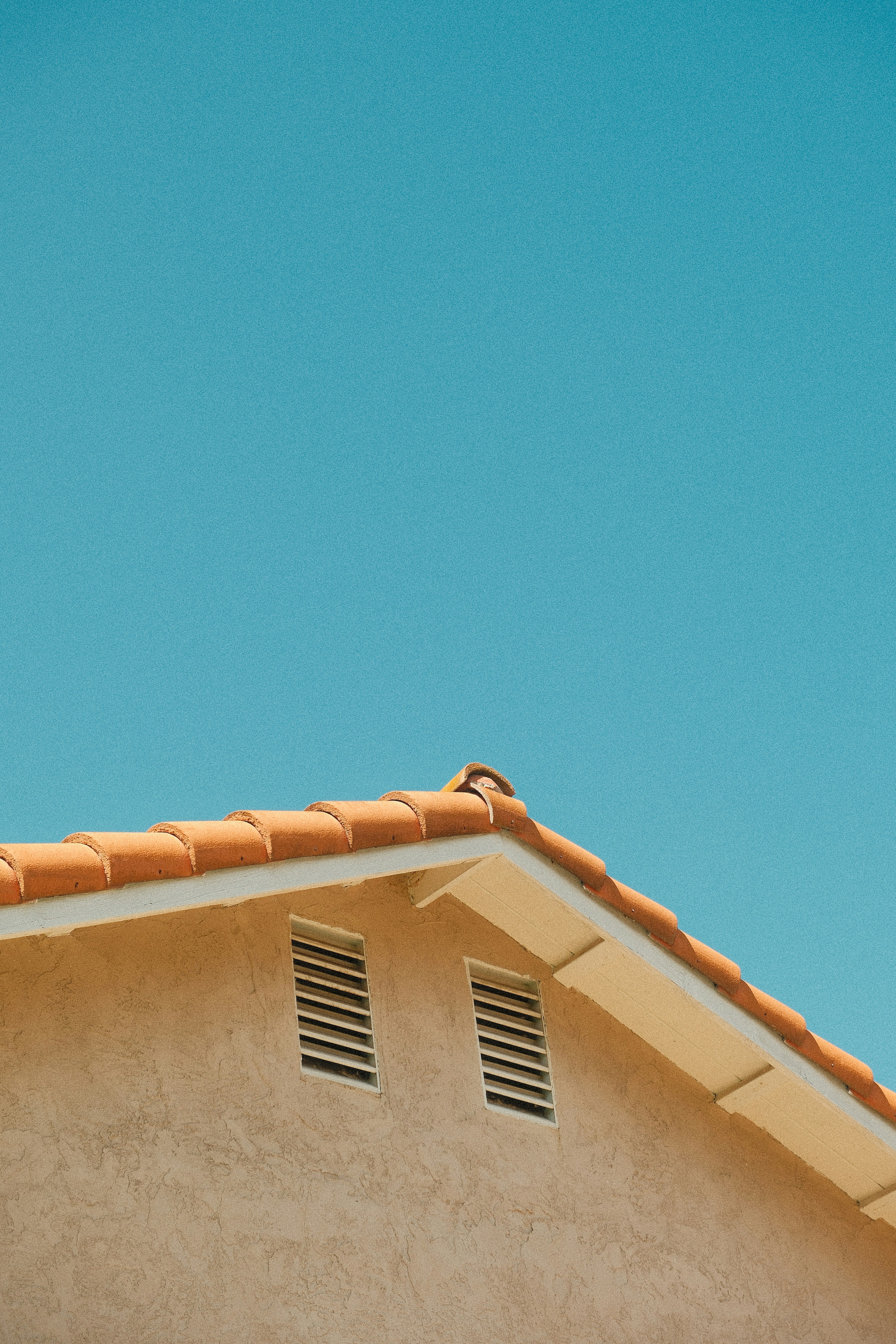 Terracotta Roofline under Aegean Sky