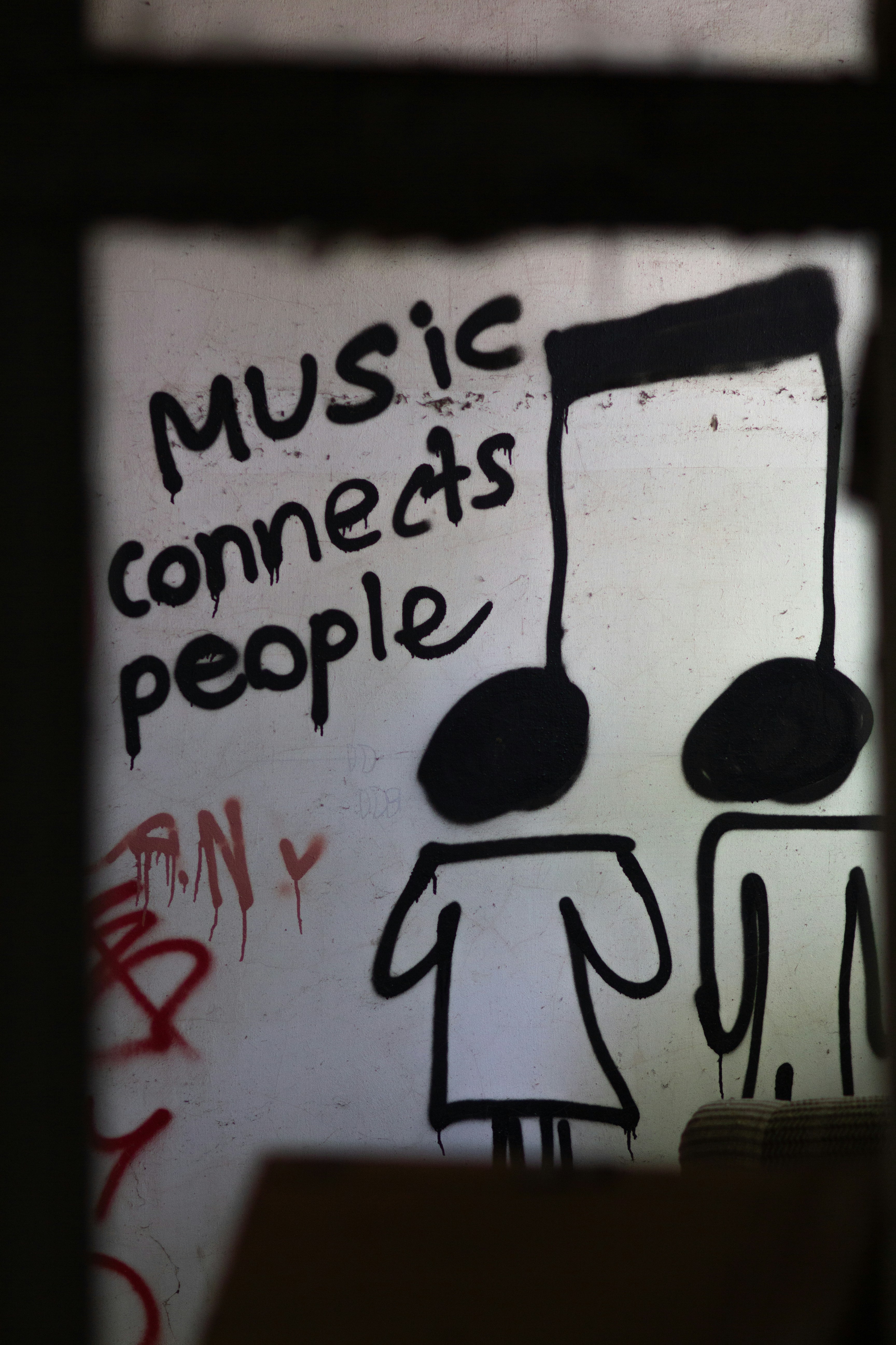 Music connects people: graffiti art on a sunlit wall