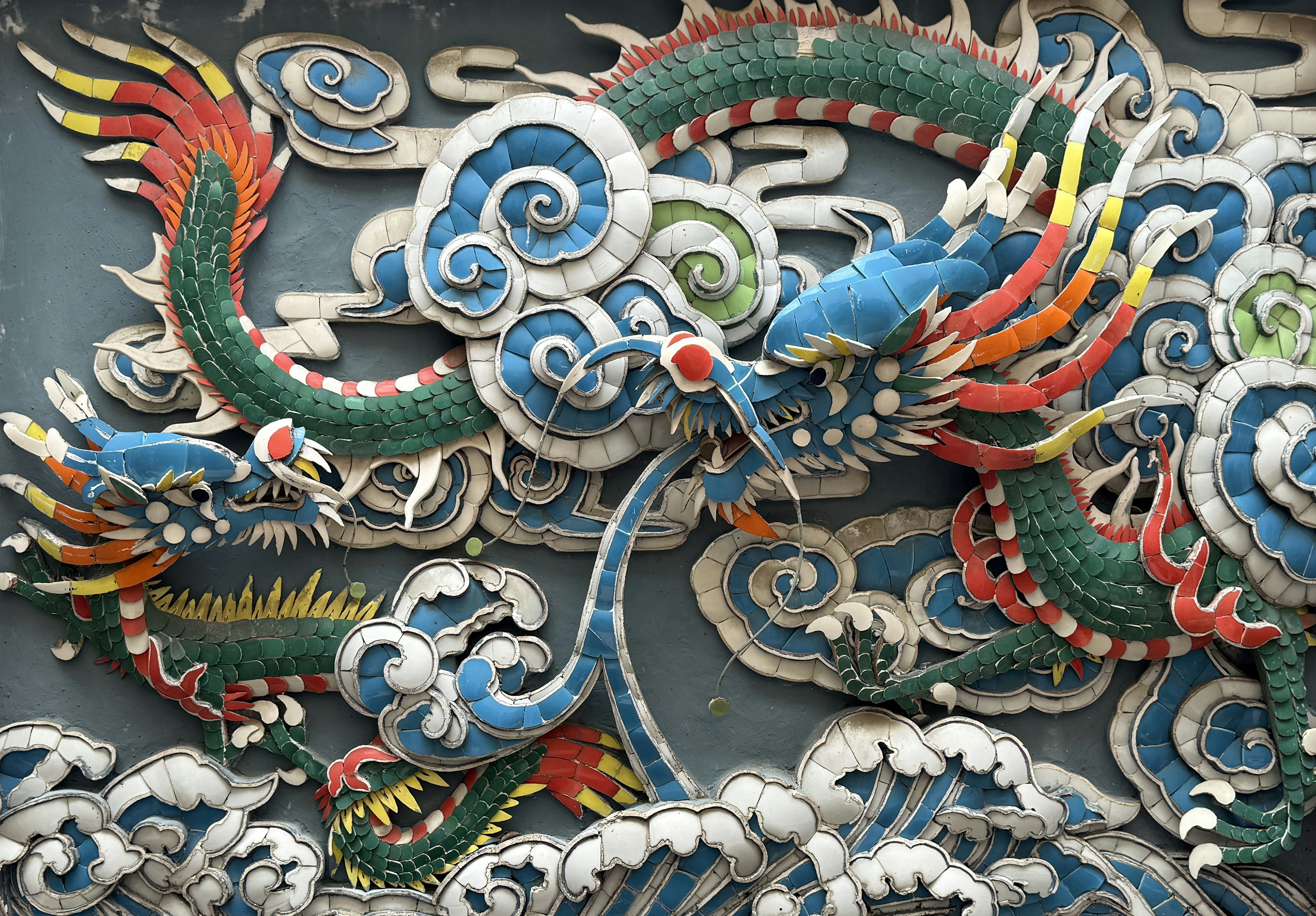 Intricate Dragon Mosaic: Colorful Carved Dragons in Alpine Cloud Motif