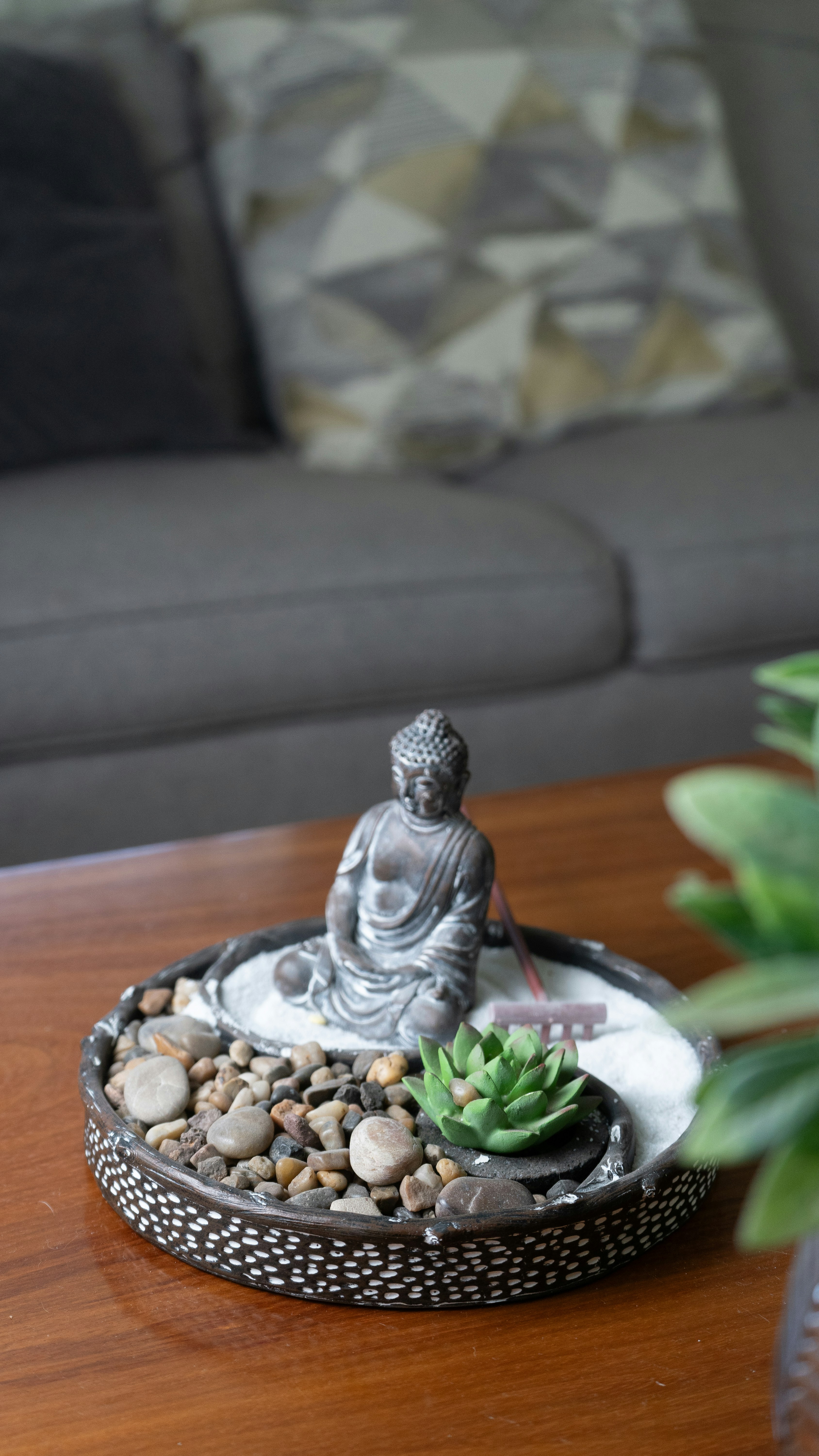 Zen Miniature: Meditating Buddha Terrarium on a Wooden Table