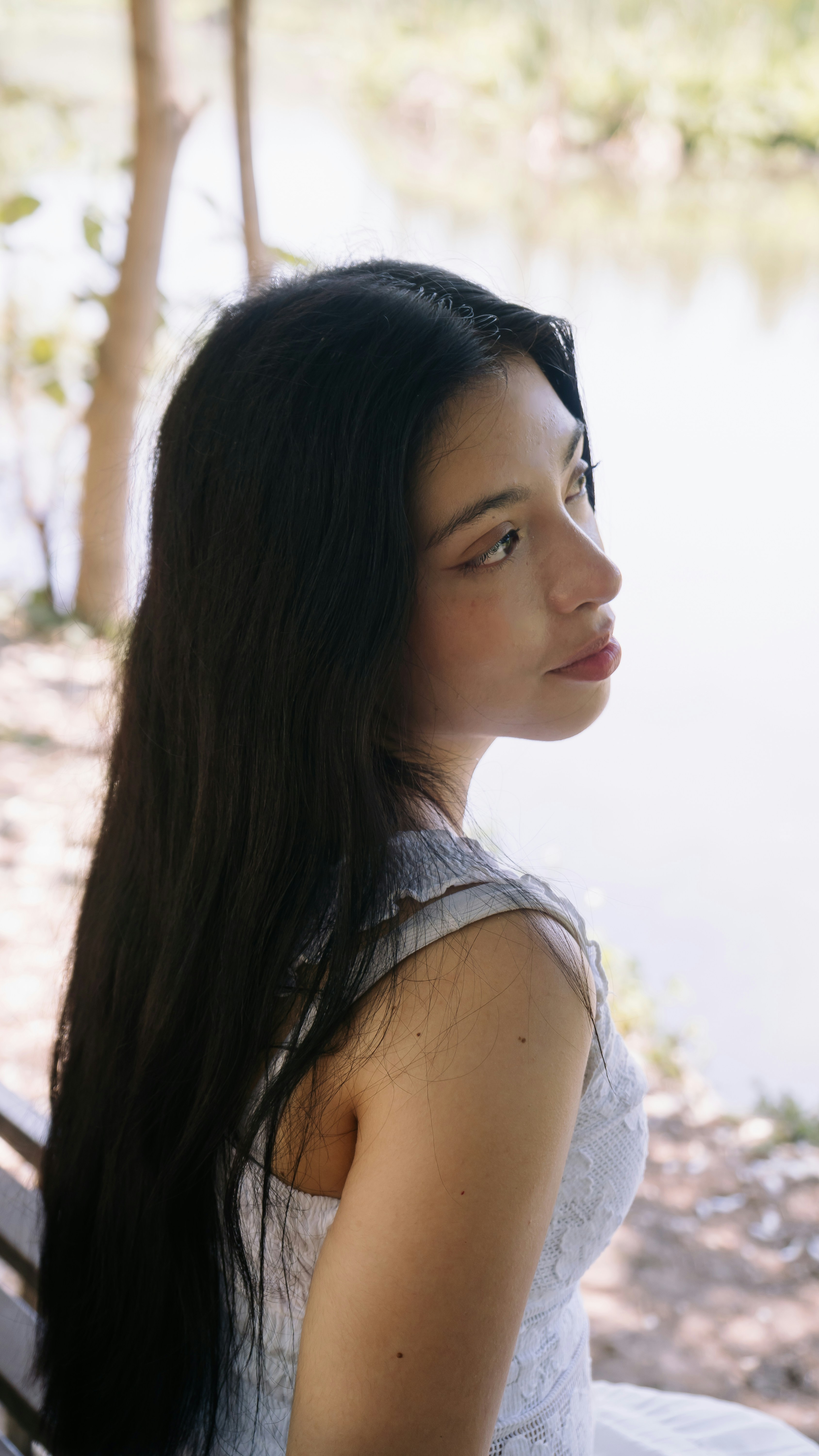 Portrait by the Lake: Soft Light on a Serene Side Profile
