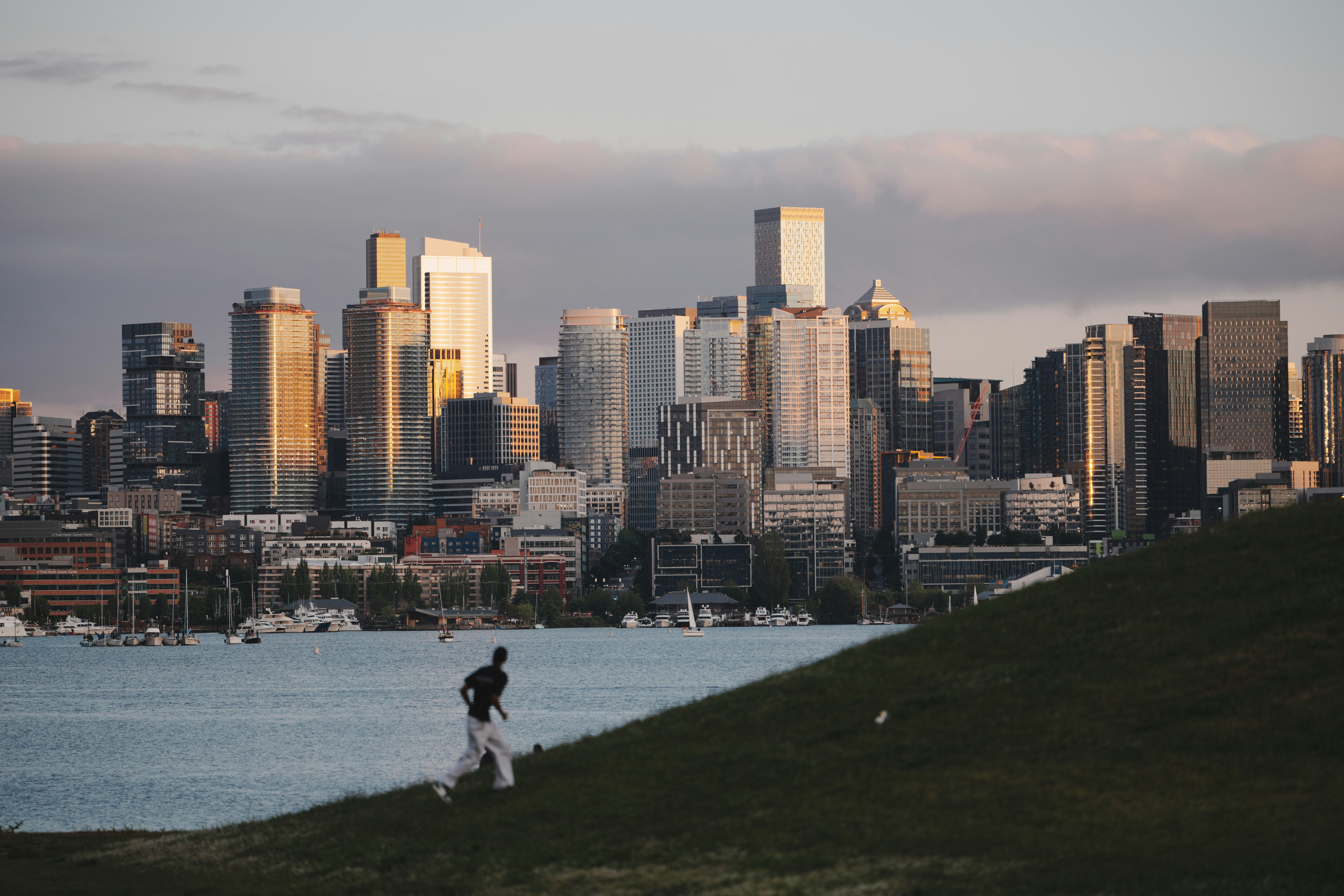 Runner by the Waterfront as Cityscape Emerges