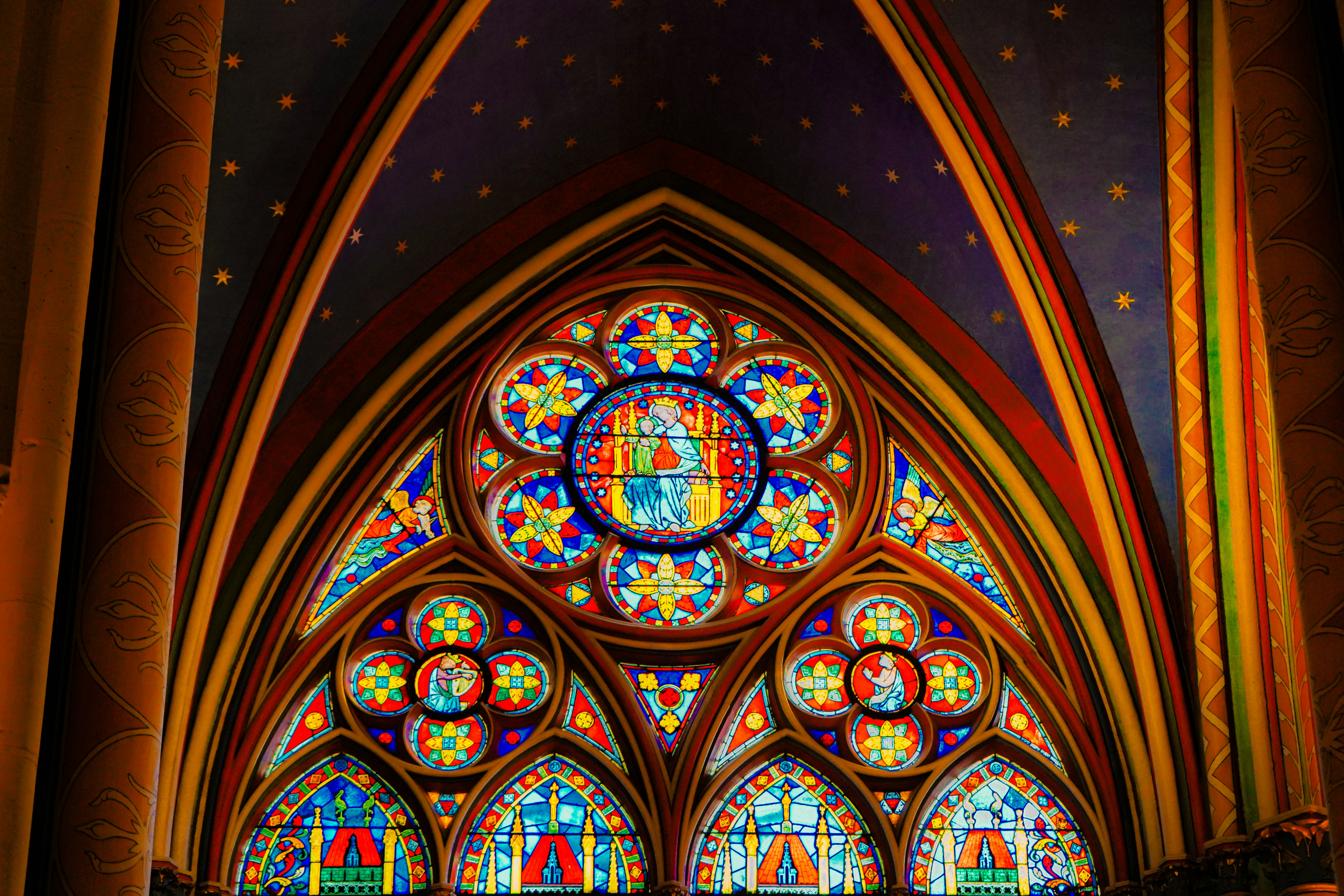 Stained Glass Cathedral: Radiant Circular Window Framed by Archway
