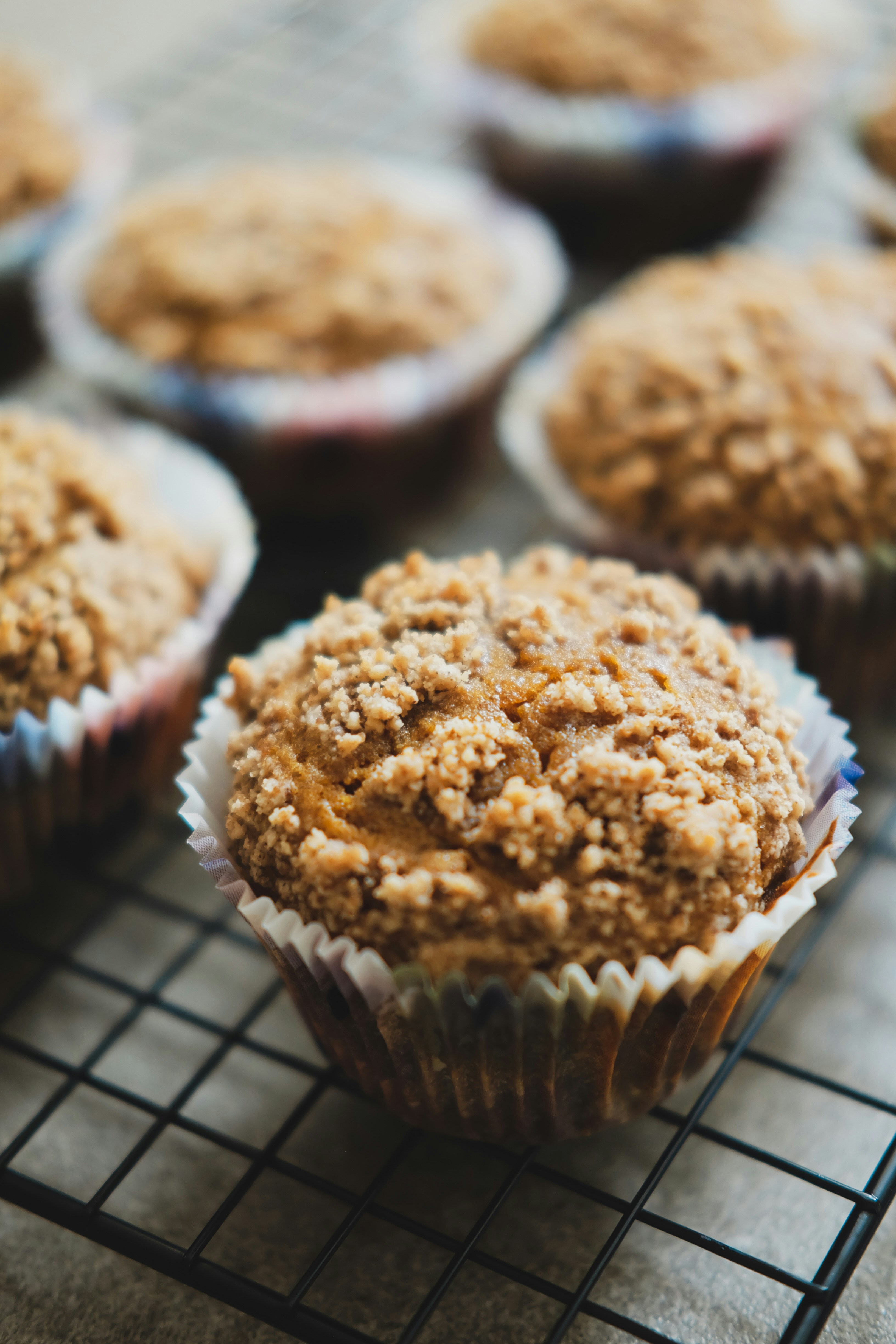 Crumb-crusted Muffin in Focus on a Cooling Rack