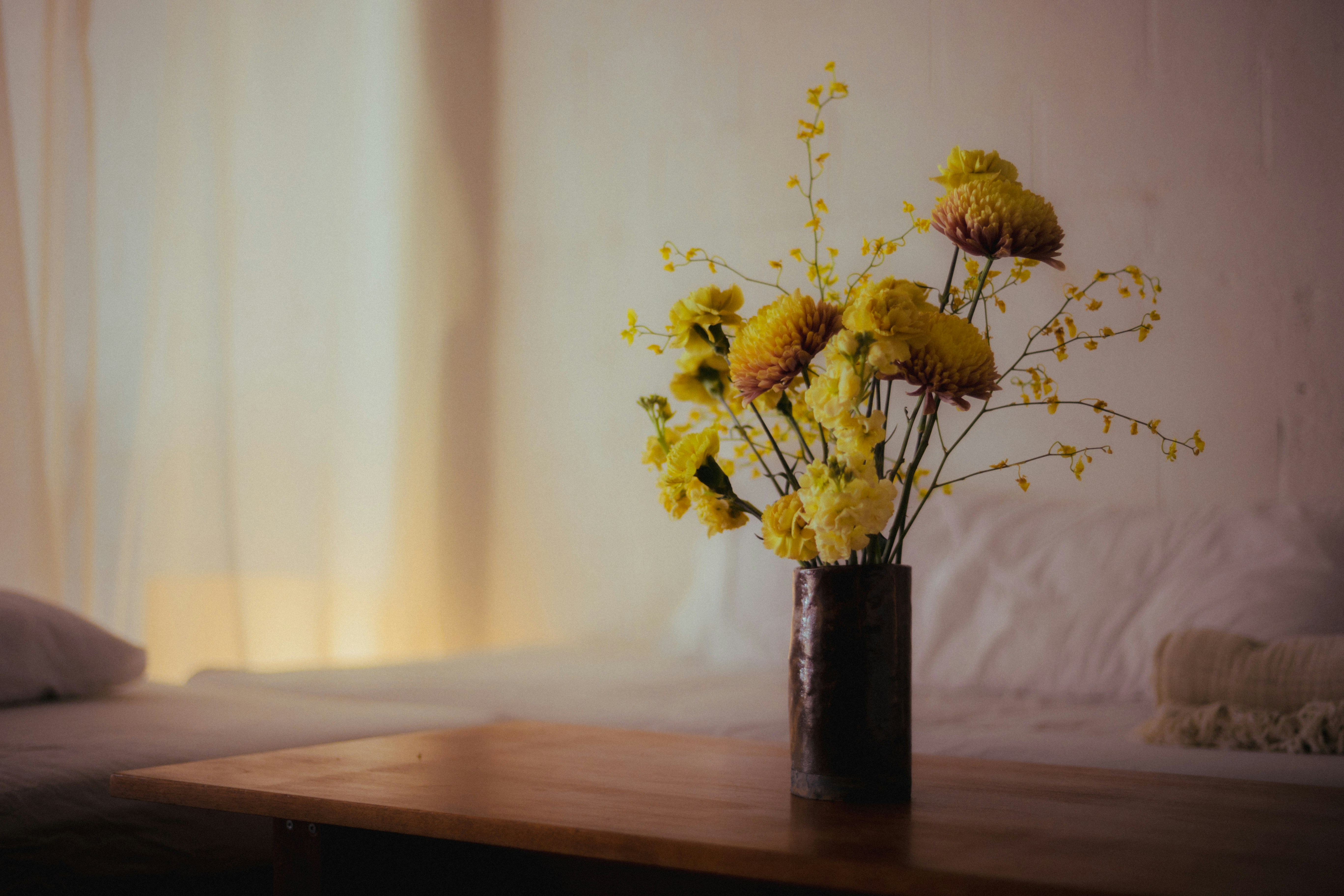 Sunlit Vase of Yellow Blossoms Anchored on a Quiet Table