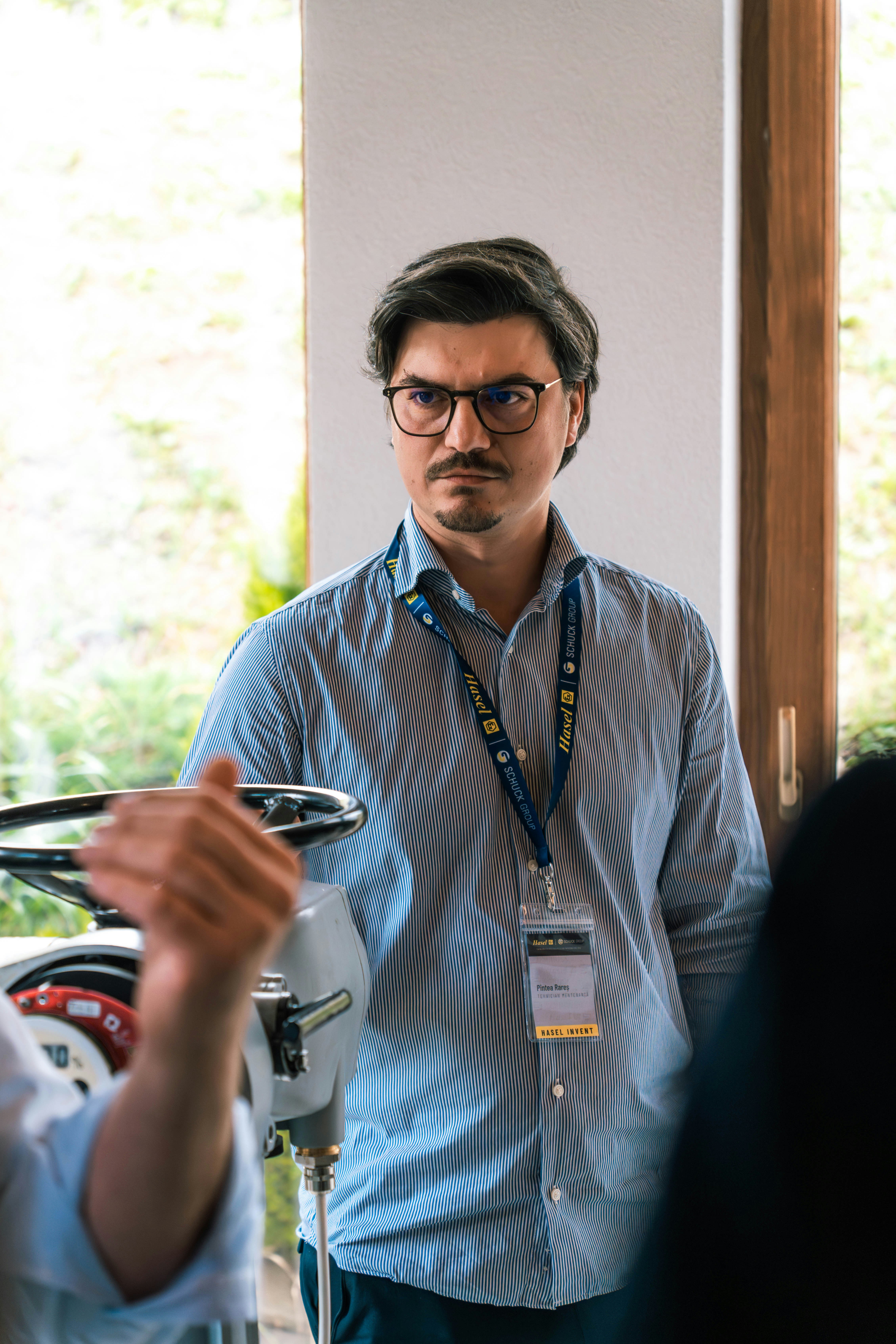 Focused Engineer in a Workshop: Portrait at the Control Wheel