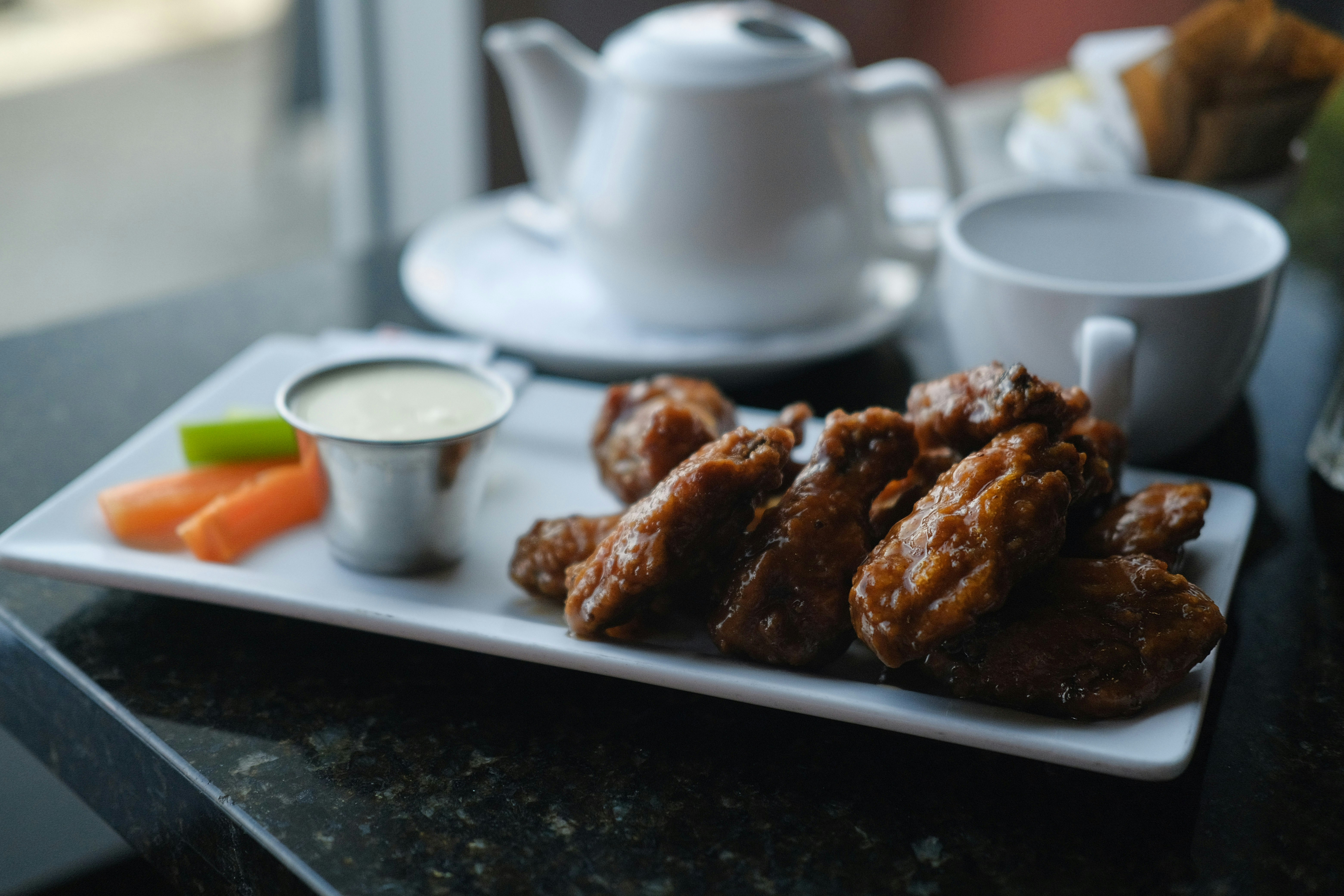 Sticky Glaze and Milk Tea Moment: Chicken Wings on a White Platter