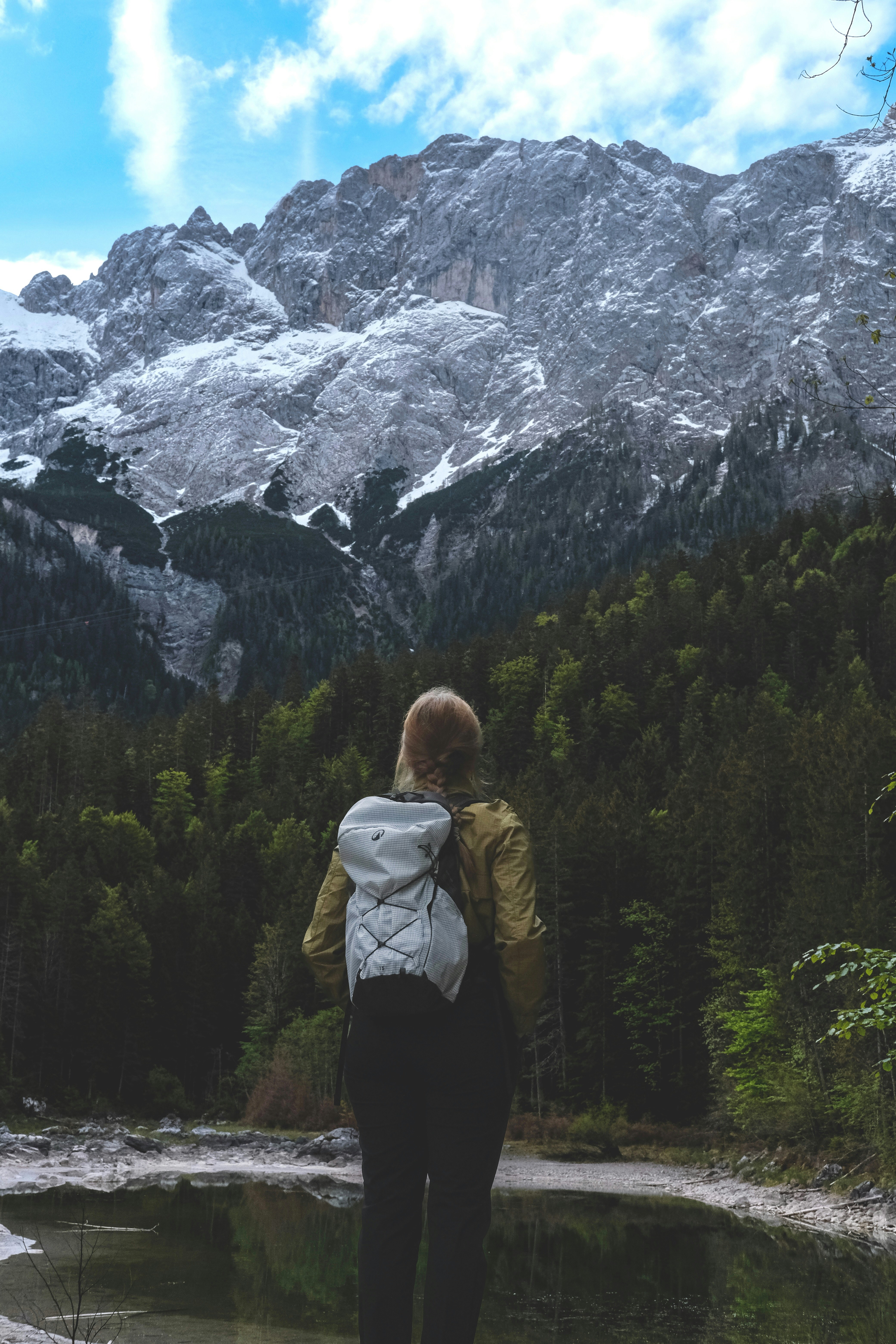 Trailbound: A Wanderer Gazing Toward Snowbound Peaks