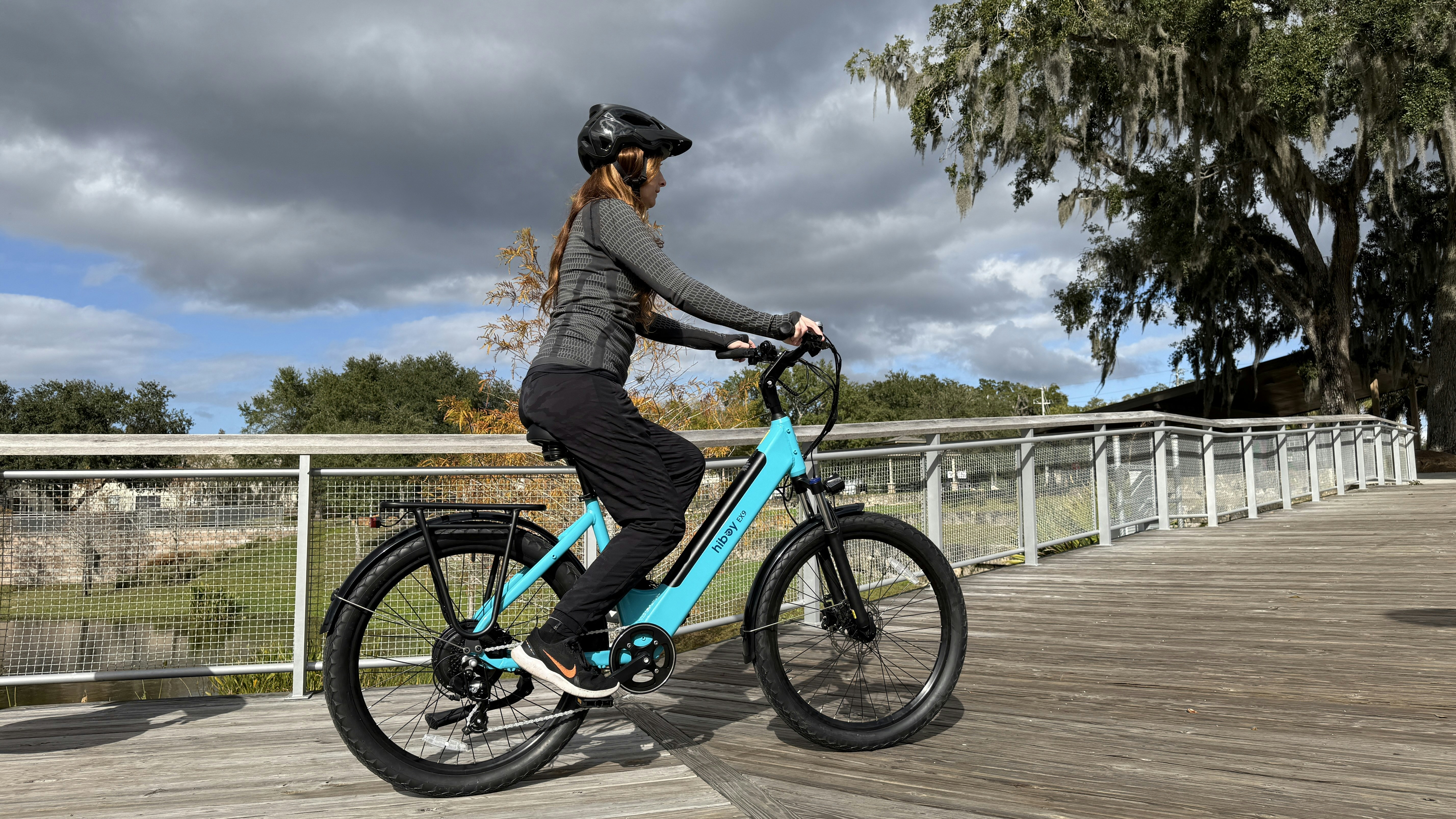 Pedaling Along the Boardwalk: A Rider in Turquoise
