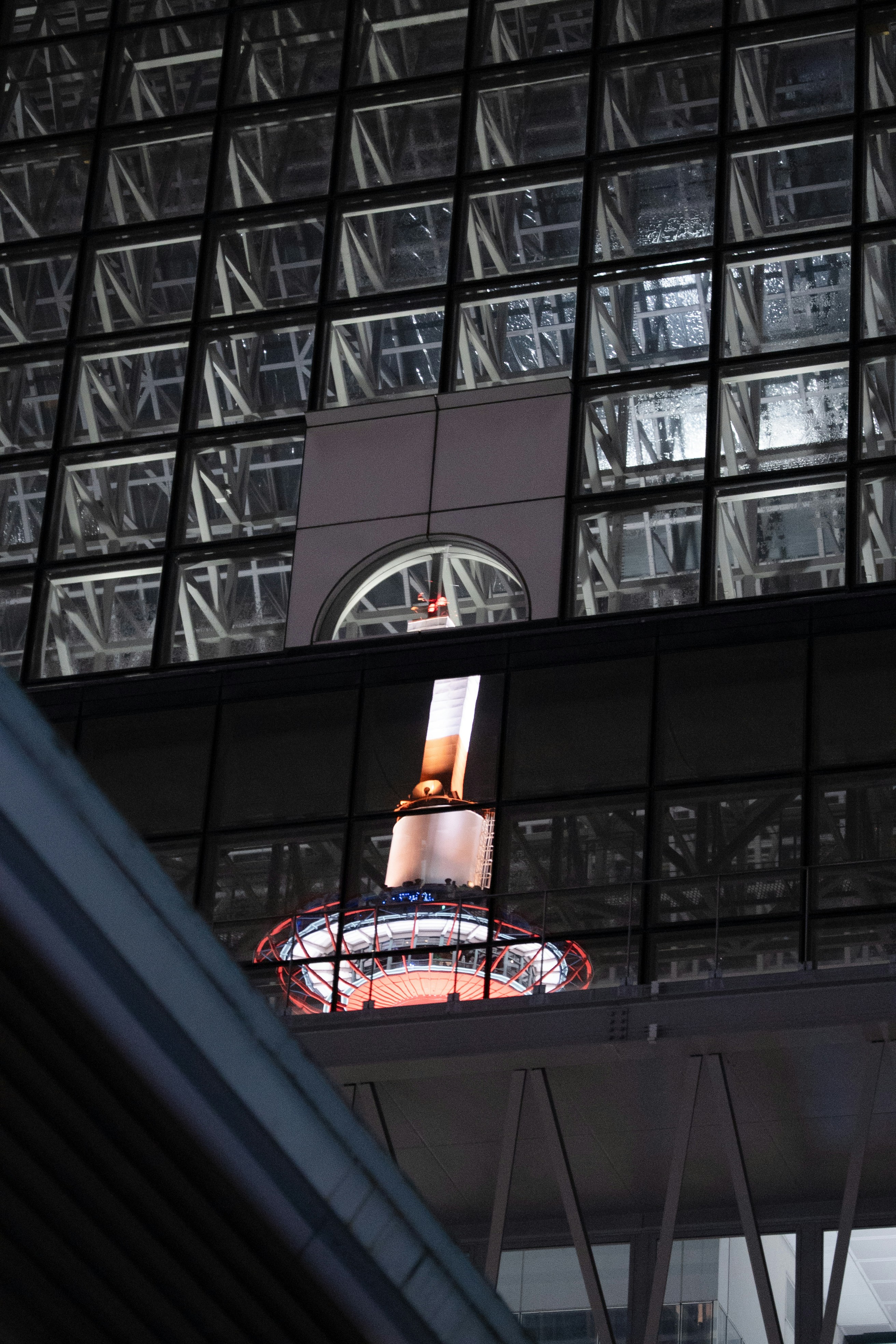 Midnight Tower behind Glass Facade