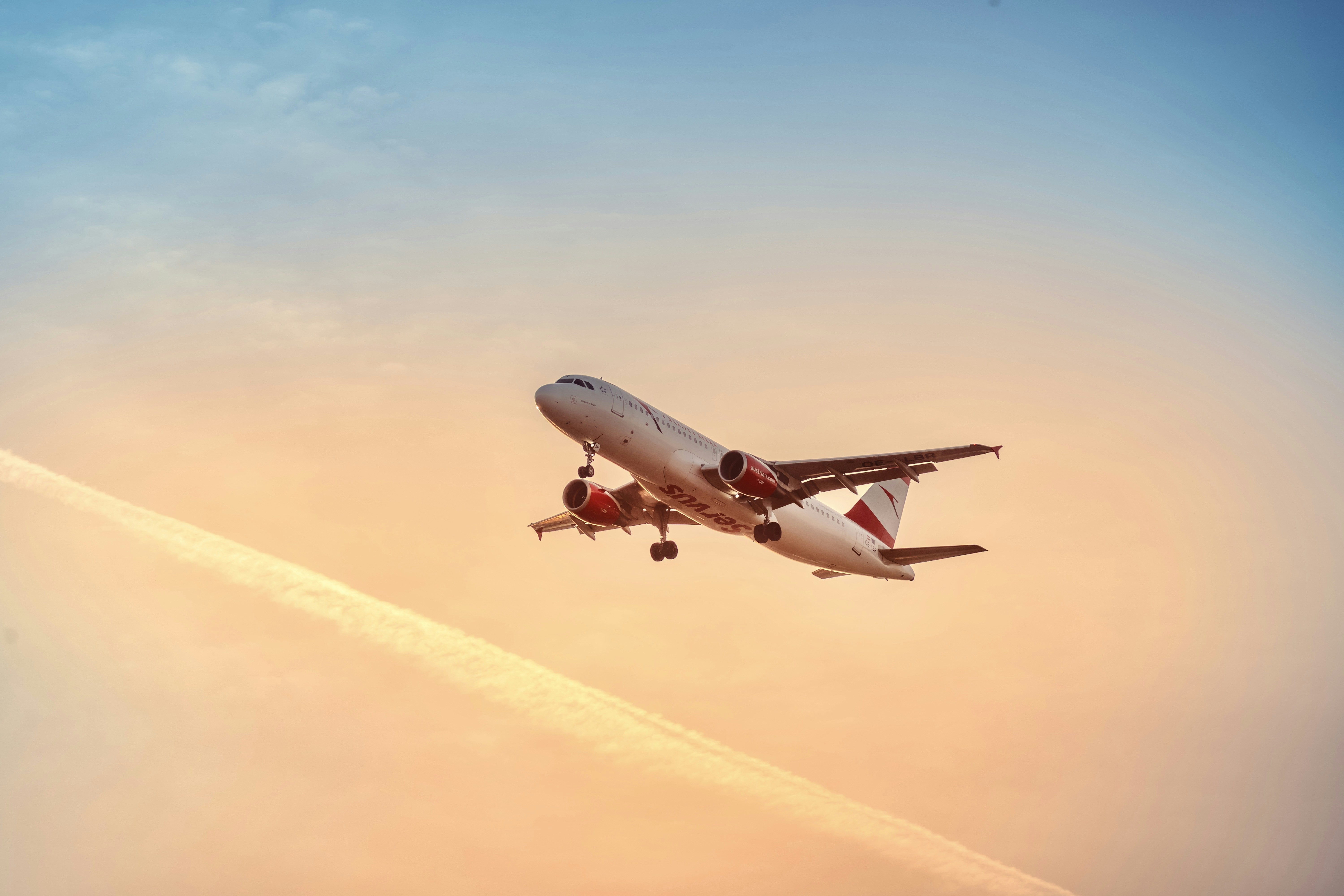 Jet Arc at Sunset: An Airliner Cleaving a Golden Horizon