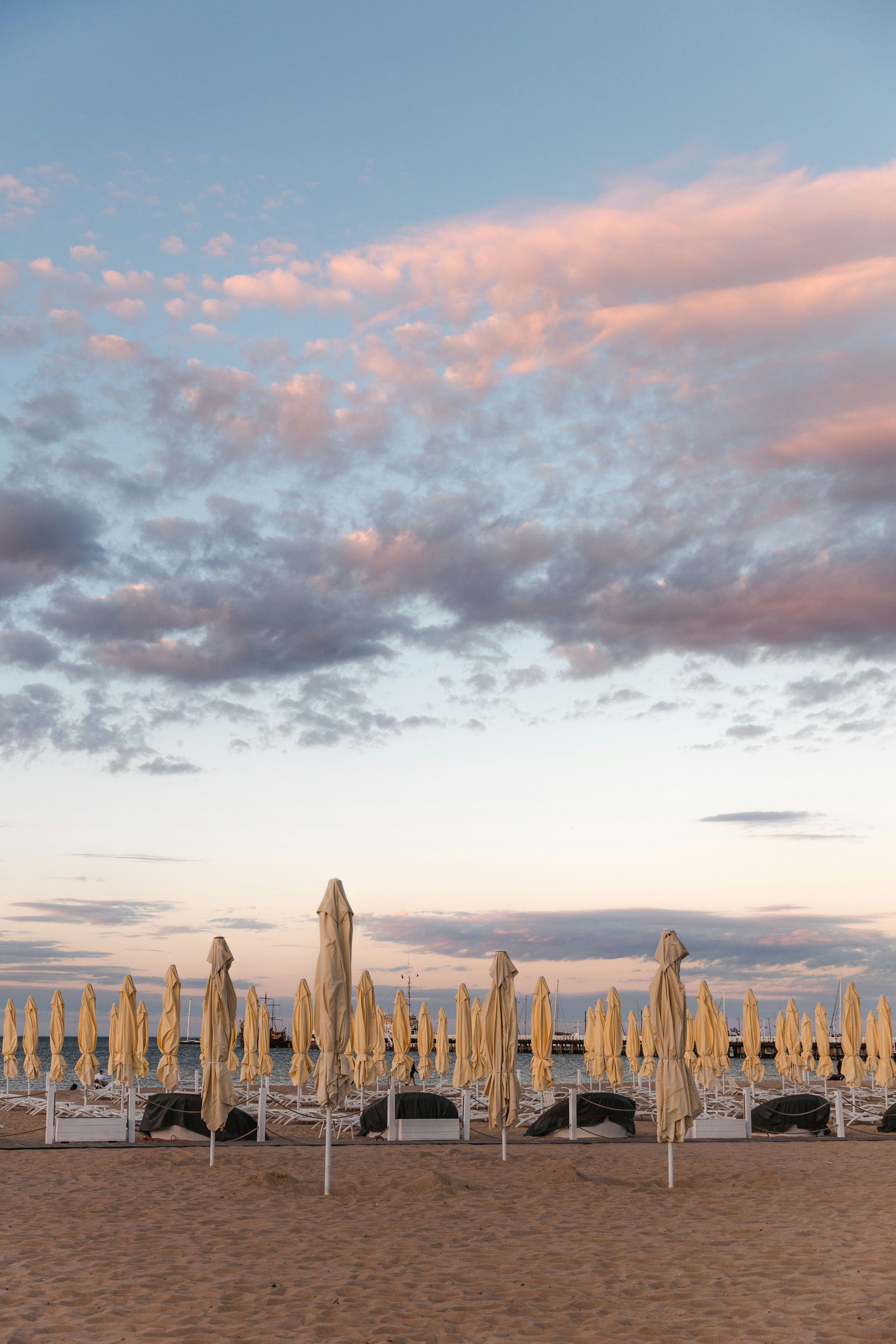 Row of Closed Beach Umbrellas at Dusk