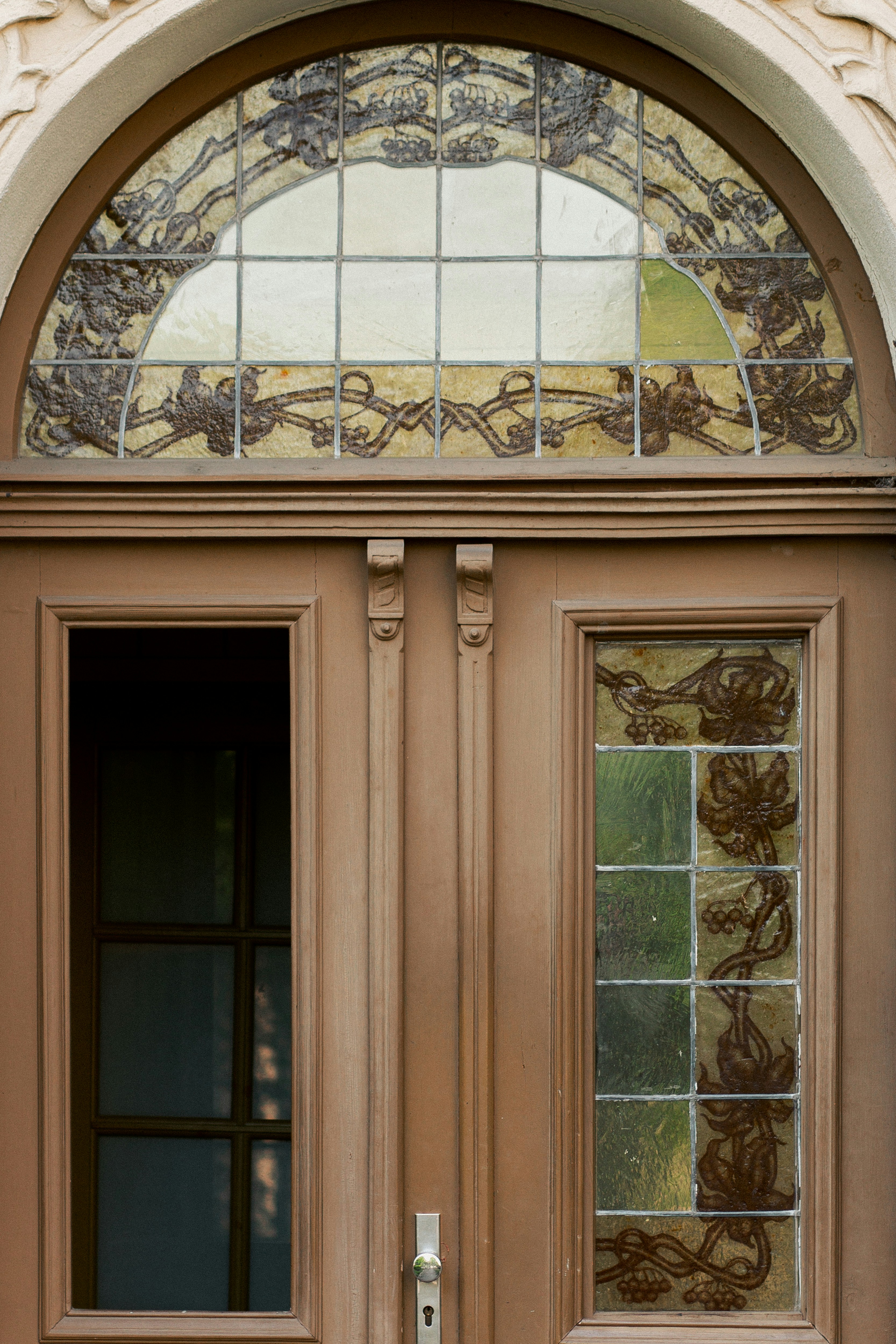 Architectural Glass and Wood: A Doorway framed by Art Nouveau Window Panels
