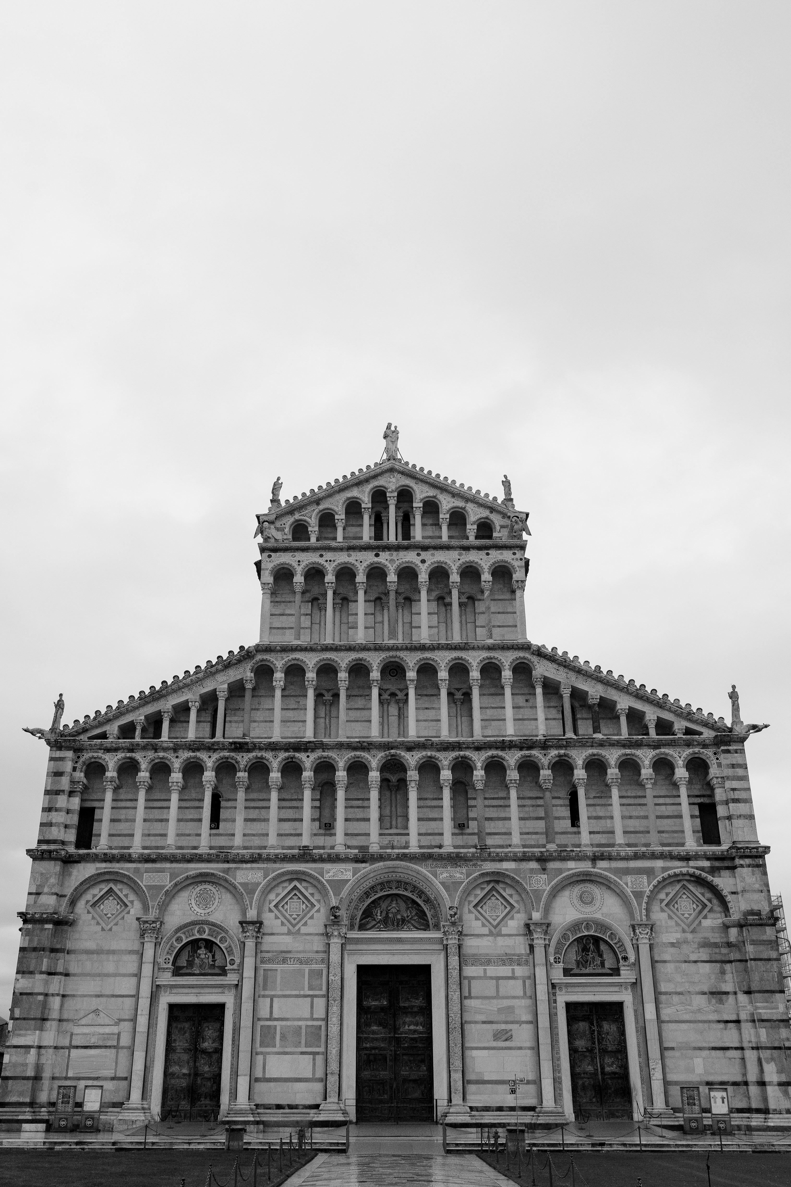 Stone Harmony: A Romanesque Facade Reaches Toward a Streaked Sky