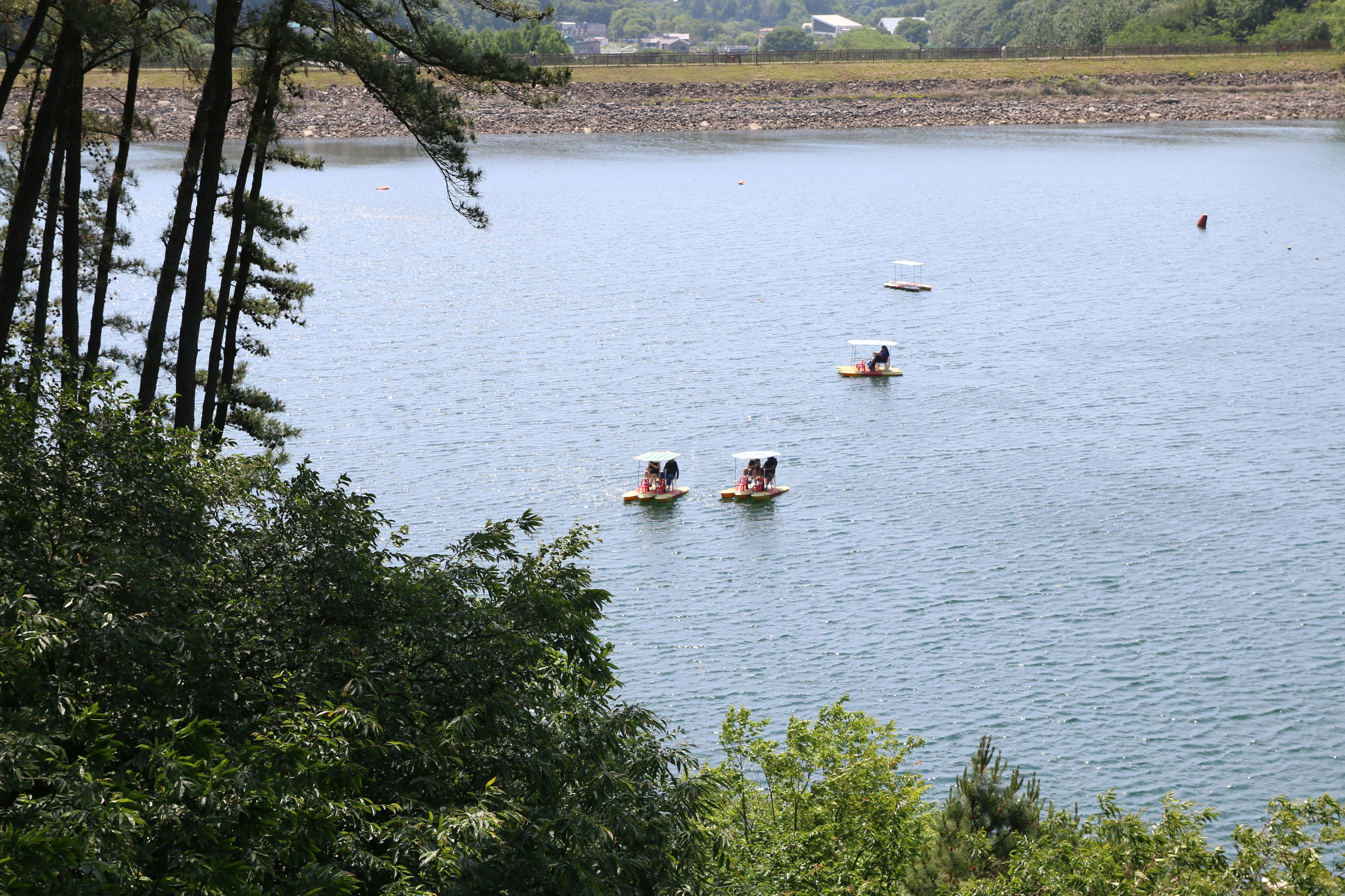 Boats Drifting Across a Calm Reservoir