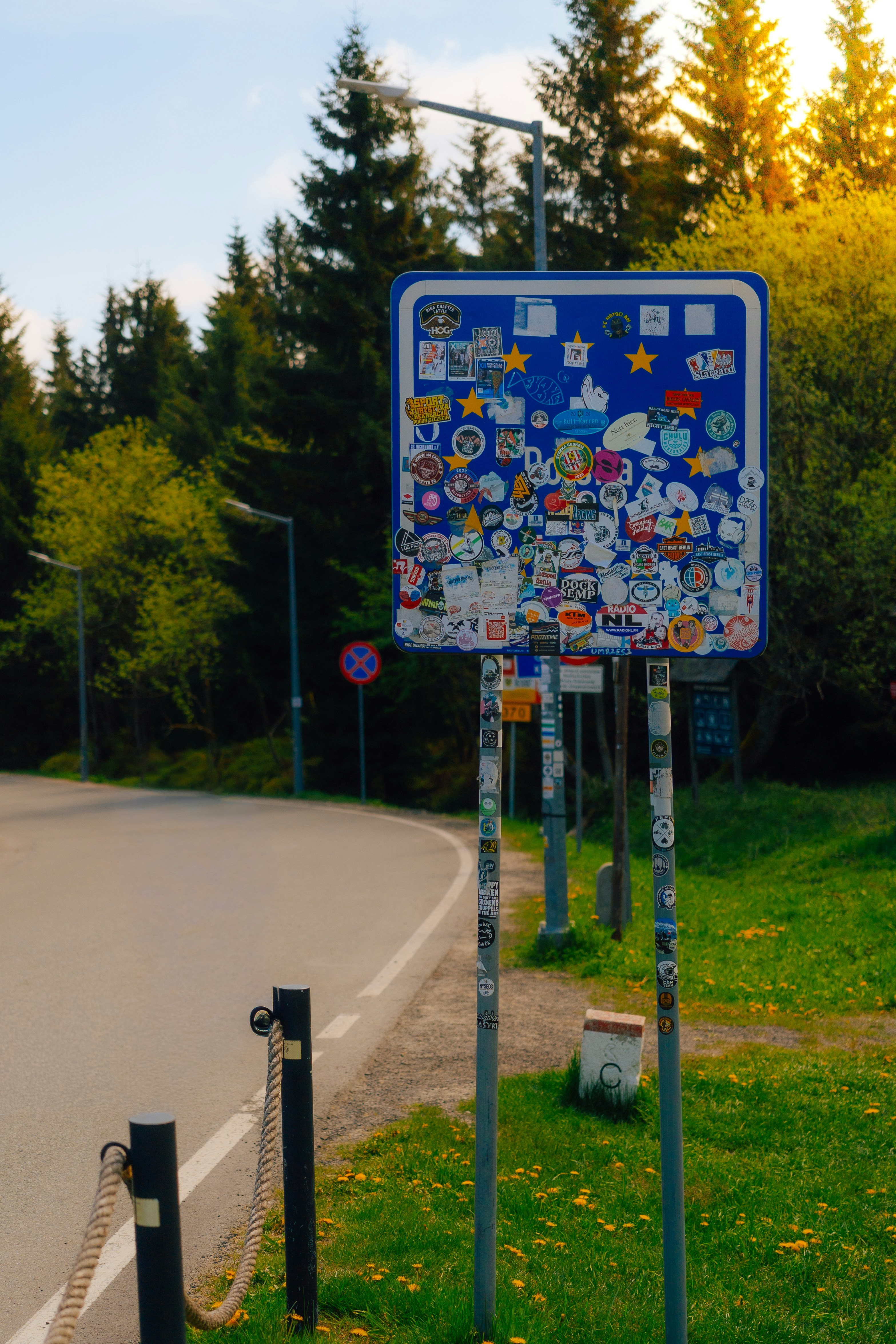 Stickered Signpost on a Quiet Drive