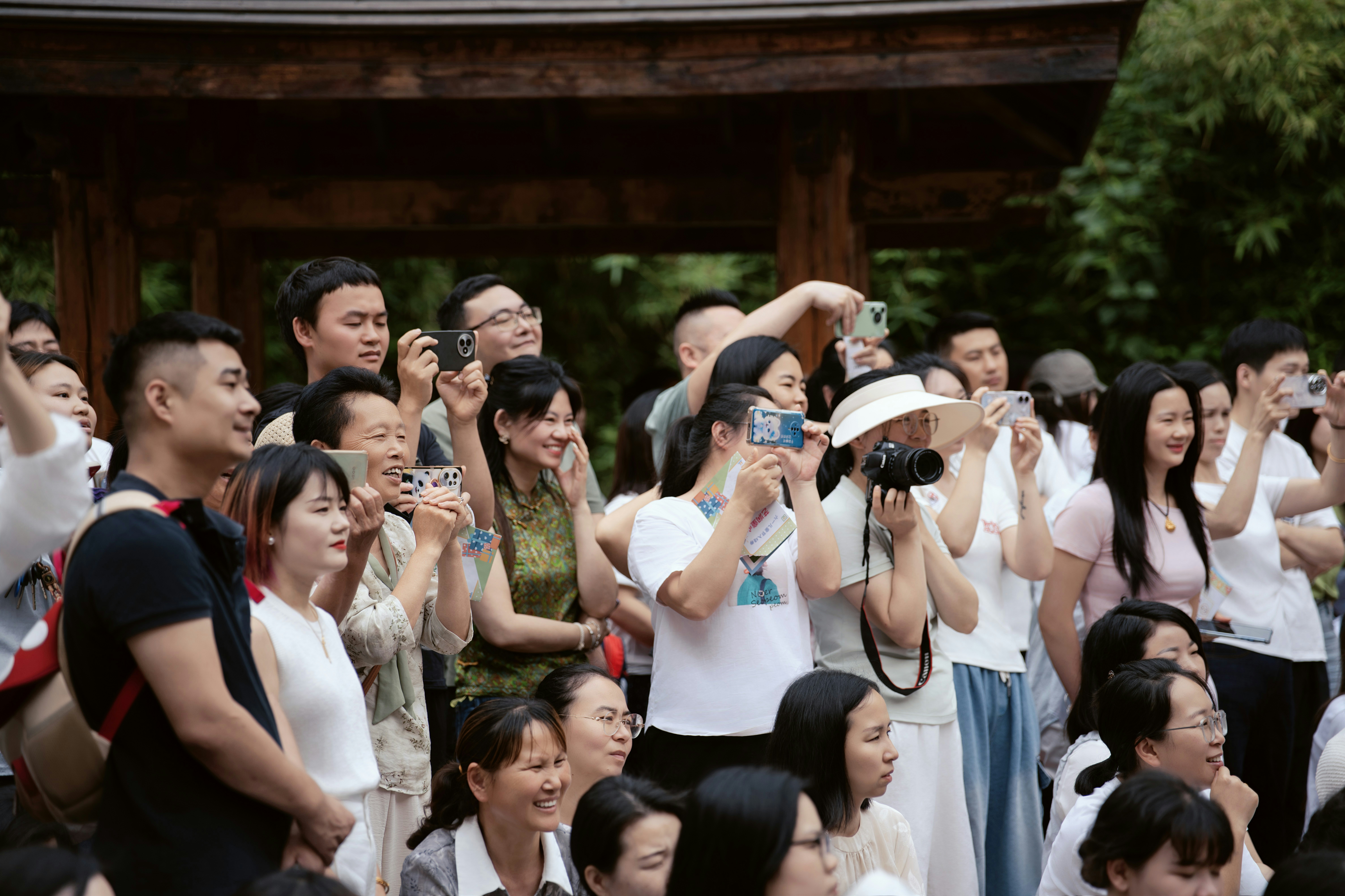Crowd of Onlookers Capturing Moments at a Public Gathering