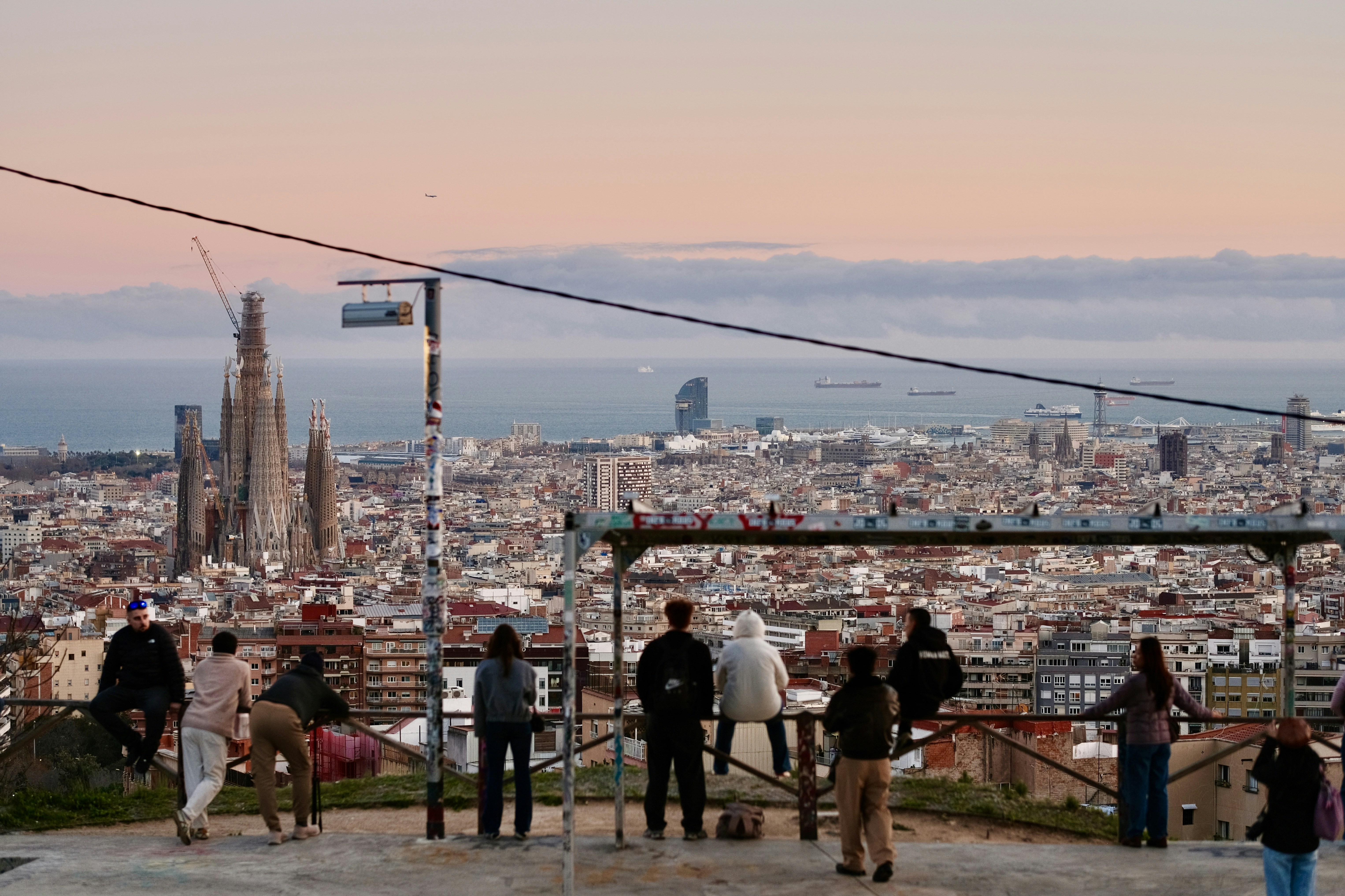 Sunset overlook over a cityscape with onlookers at a viewpoint