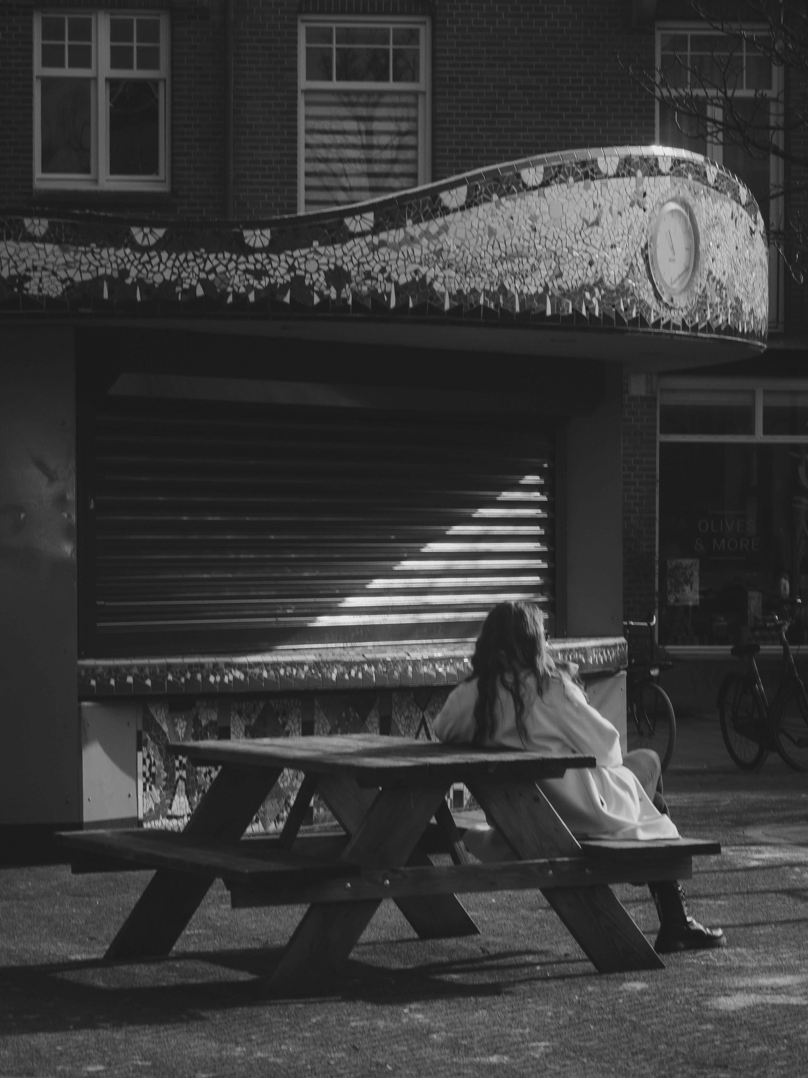 Quiet Refuge: A Figure at a Sunlit Picnic Table