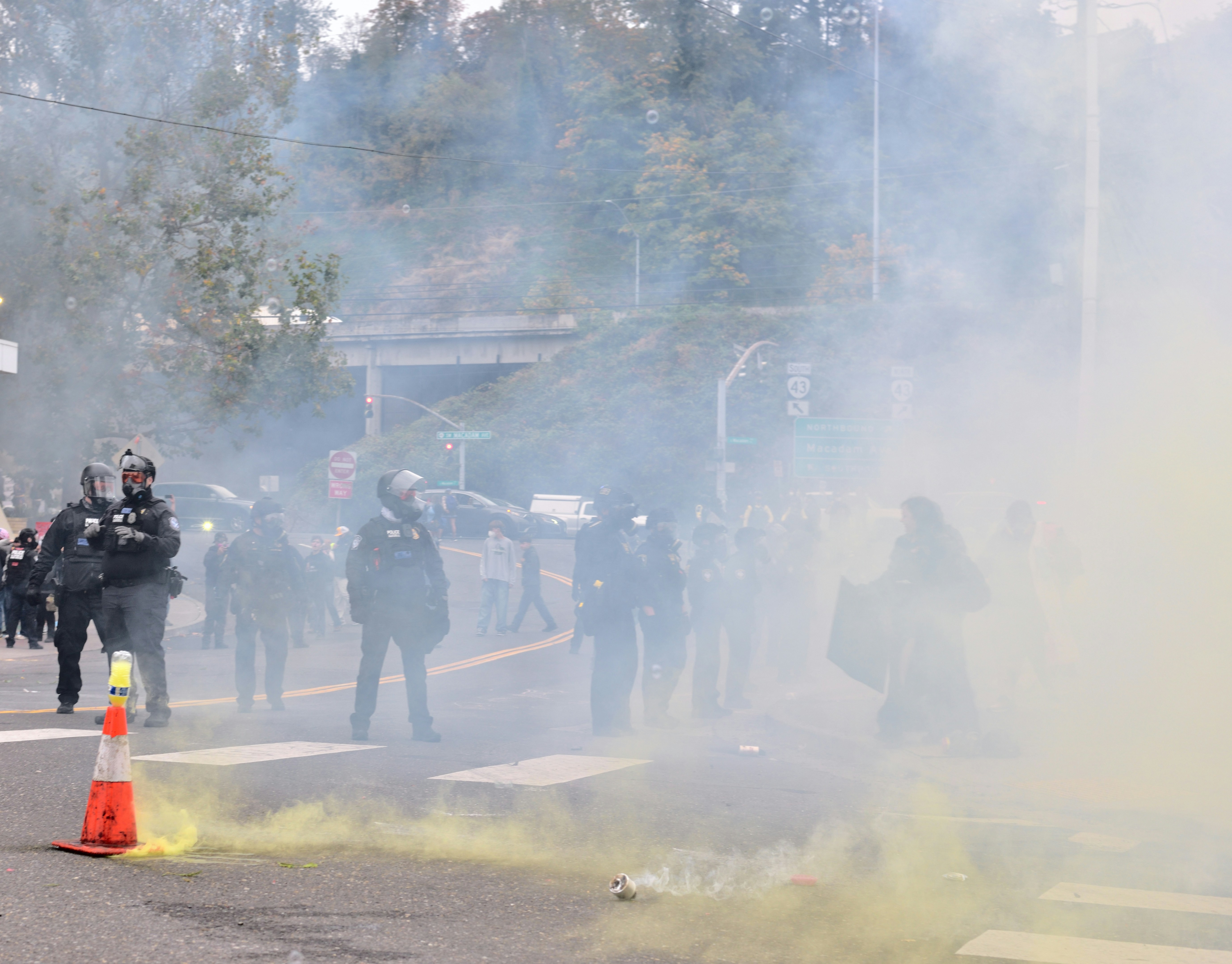 Smoke and Silence on the Street: Police Line Amid Civil Unrest